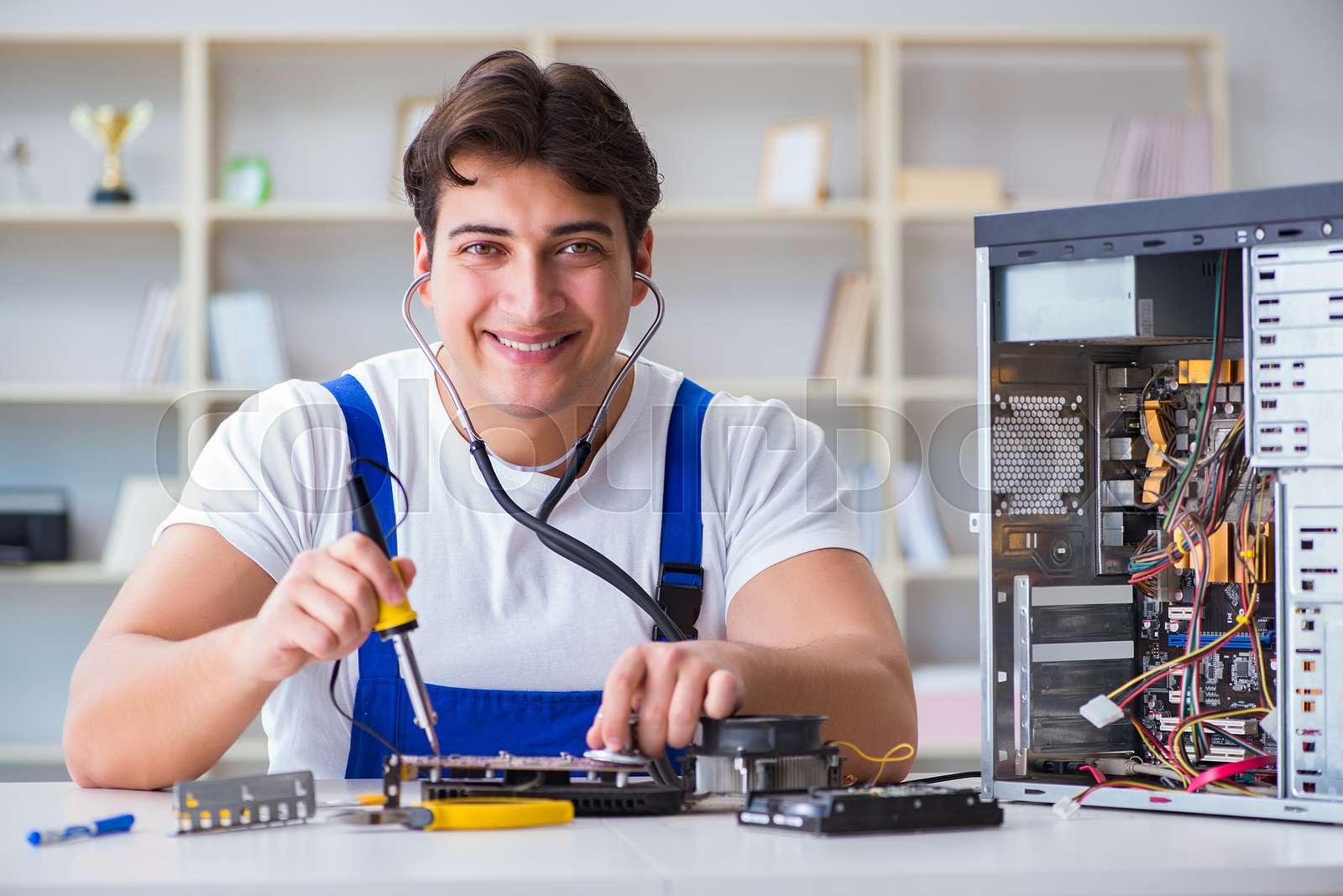 Computer repairman repairing desktop computer | Stock image | Colourbox