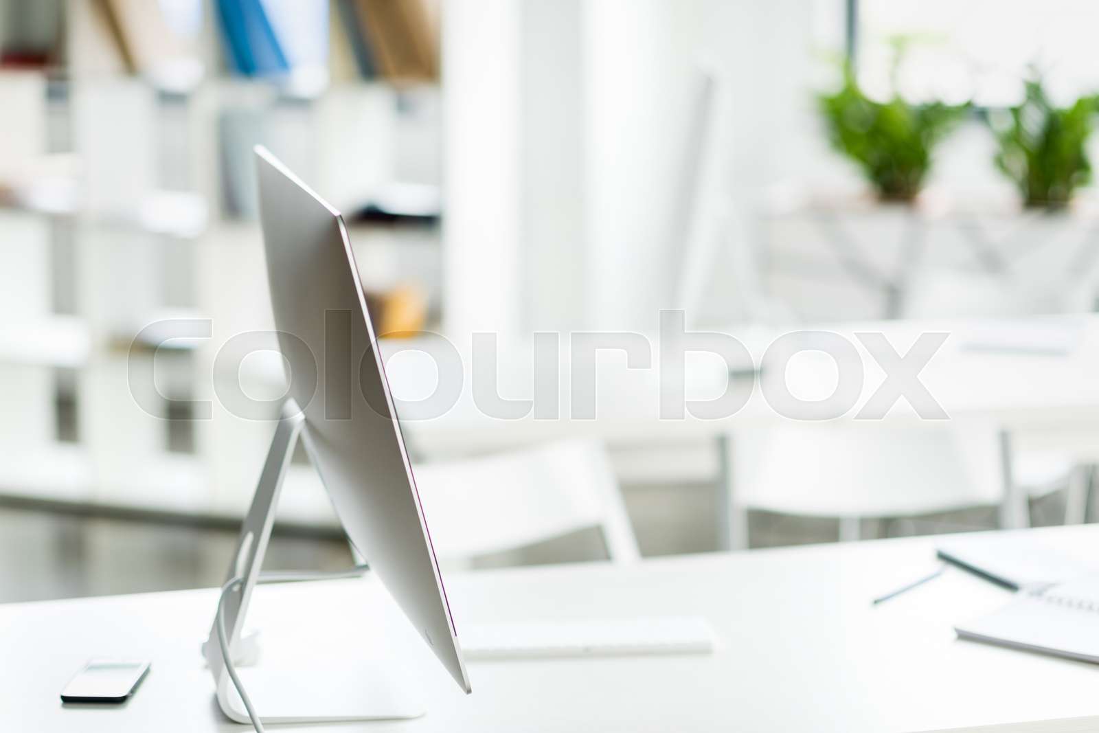close-up-view-of-computer-monitor-and-smartphone-on-table-in-computer