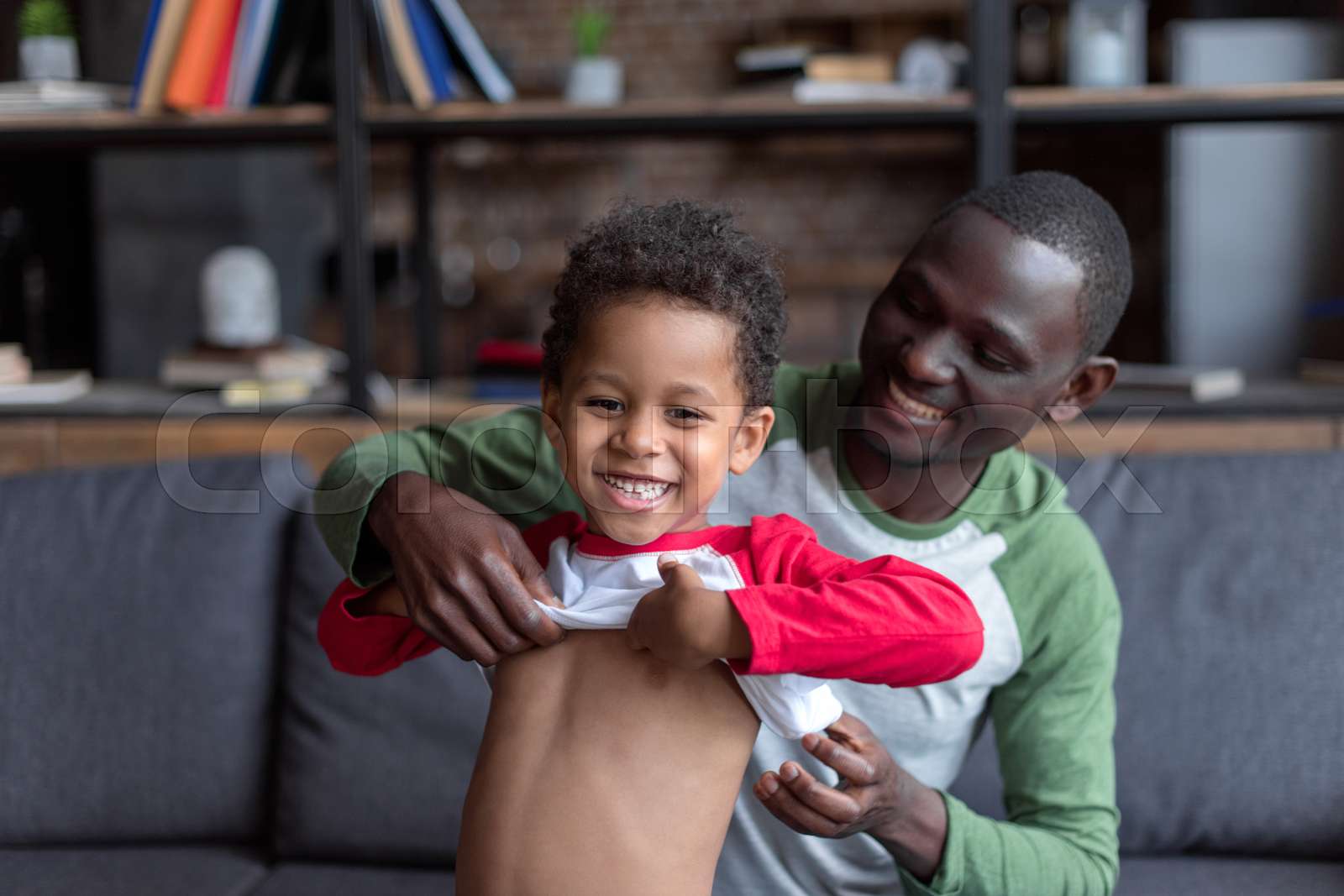 father dressing up his son | Stock image | Colourbox