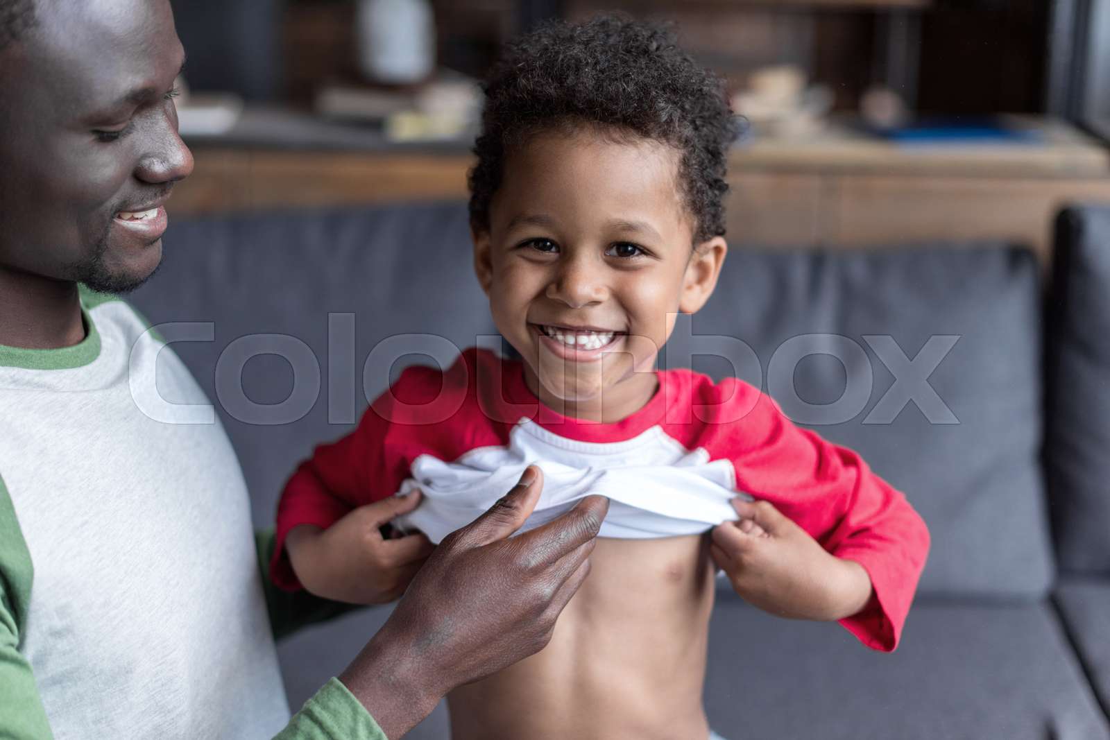 father dressing up his son | Stock image | Colourbox