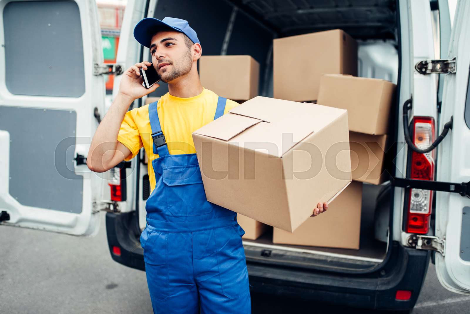 Cargo delivery service, courier with box and phone | Stock image ...