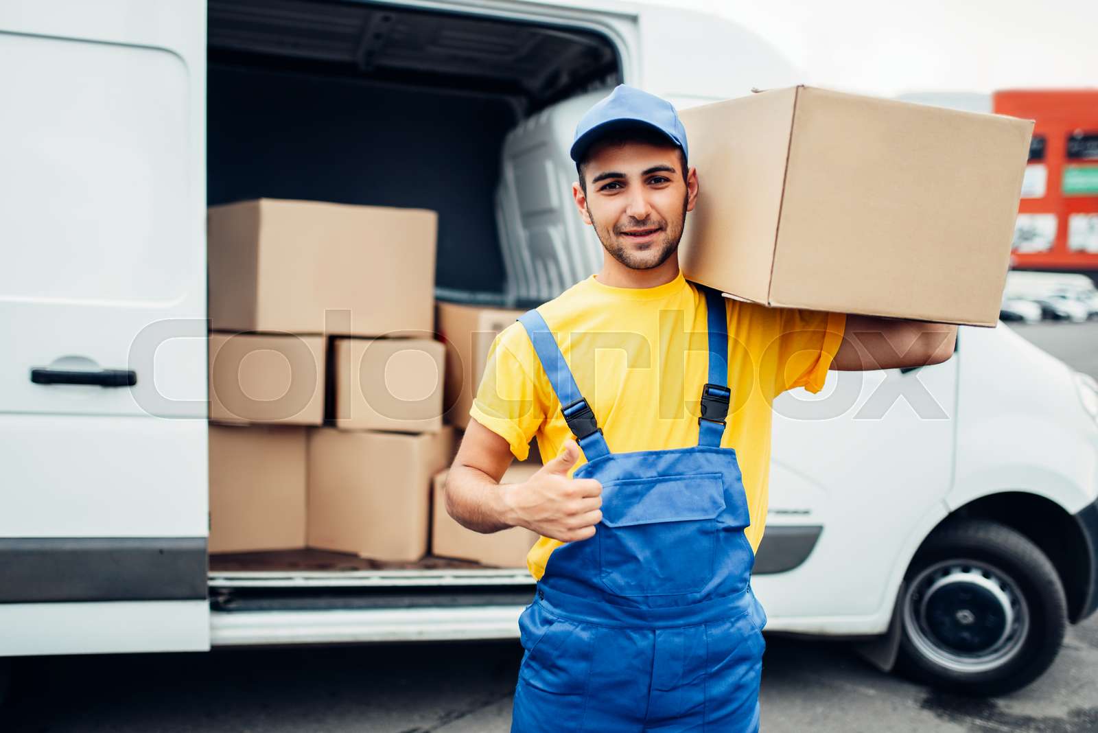 Cargo delivery service, male worker thumb up | Stock image | Colourbox