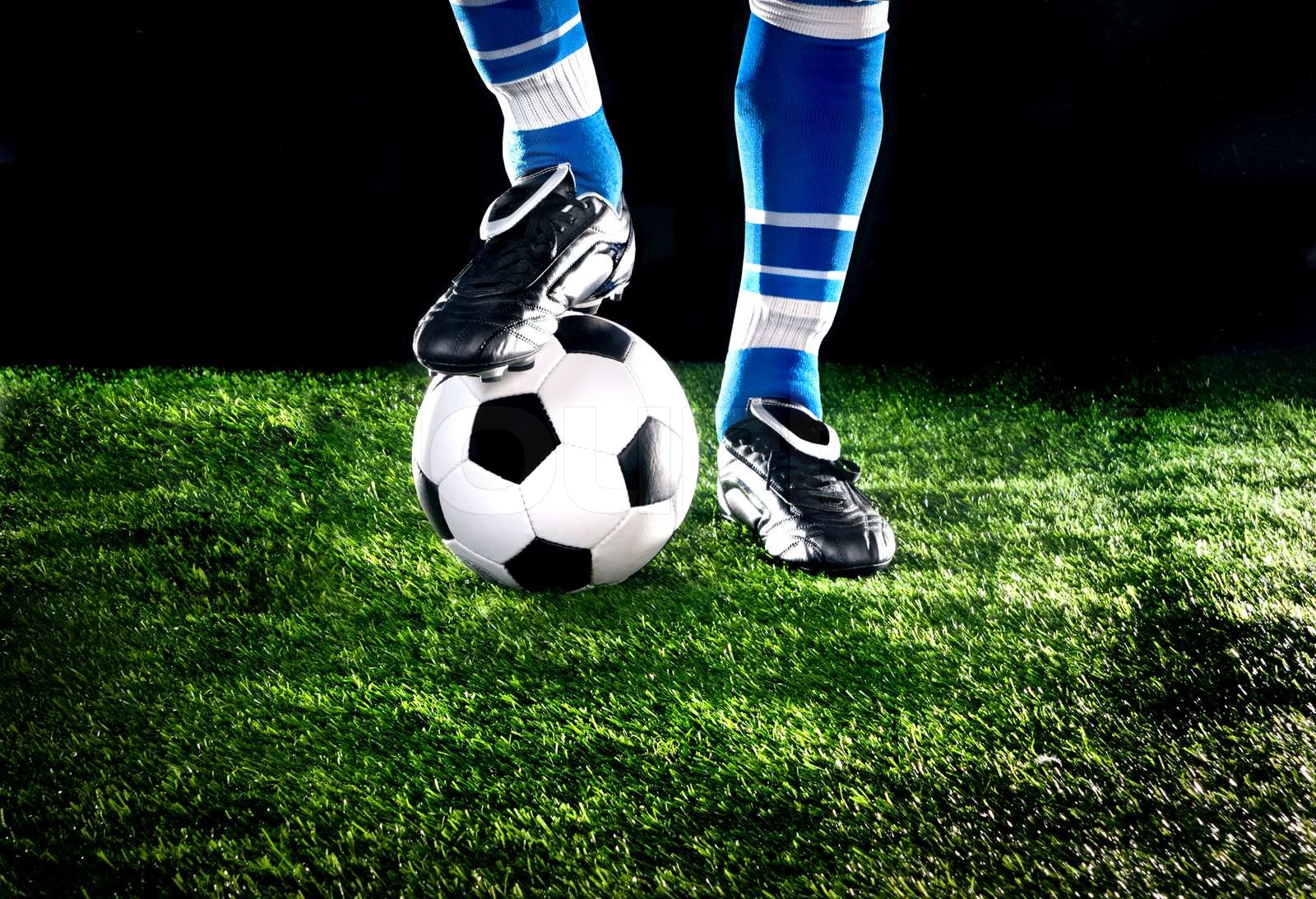 soccer ball with his feet on the football field | Stock image | Colourbox