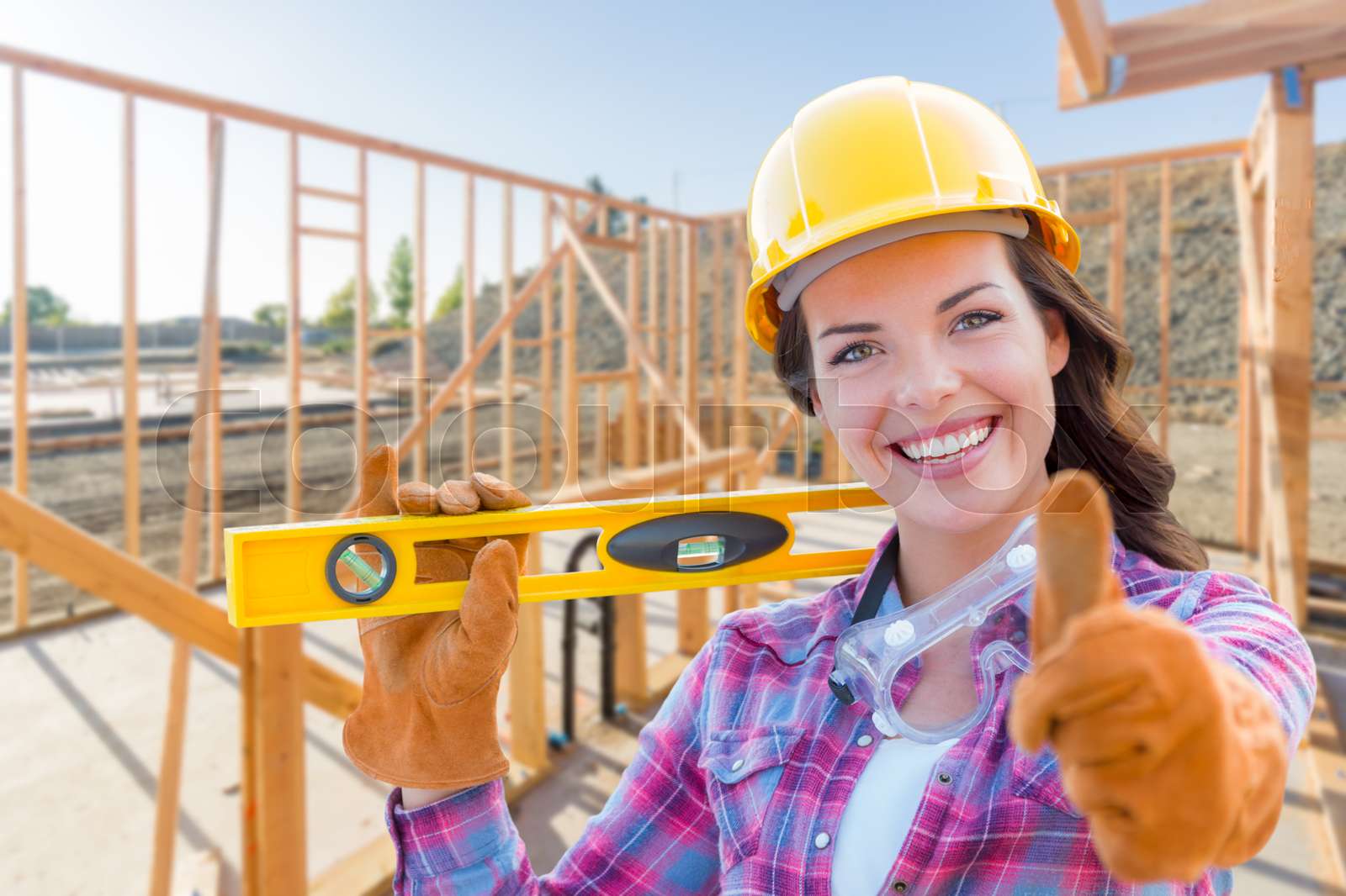 Female Construction Worker with Thumbs Up Holding Level Wearing Gloves ...