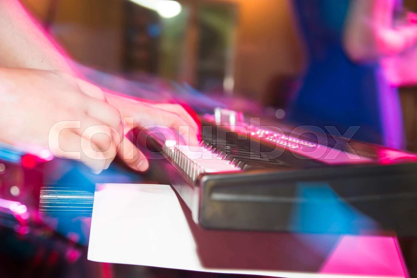 Musician plays keyboards in a rock band | Stock image | Colourbox