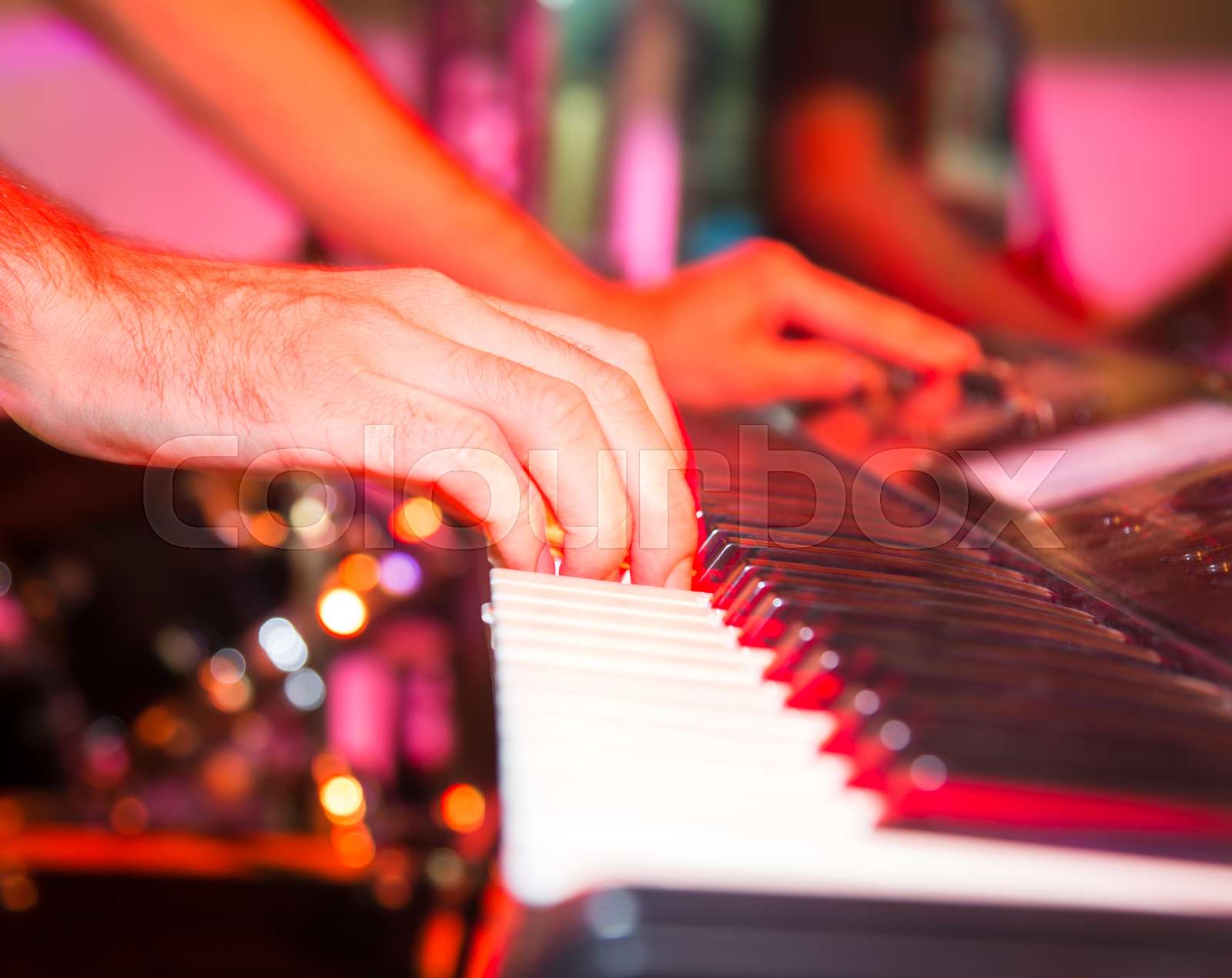 Musician plays keyboards in a rock band | Stock image | Colourbox