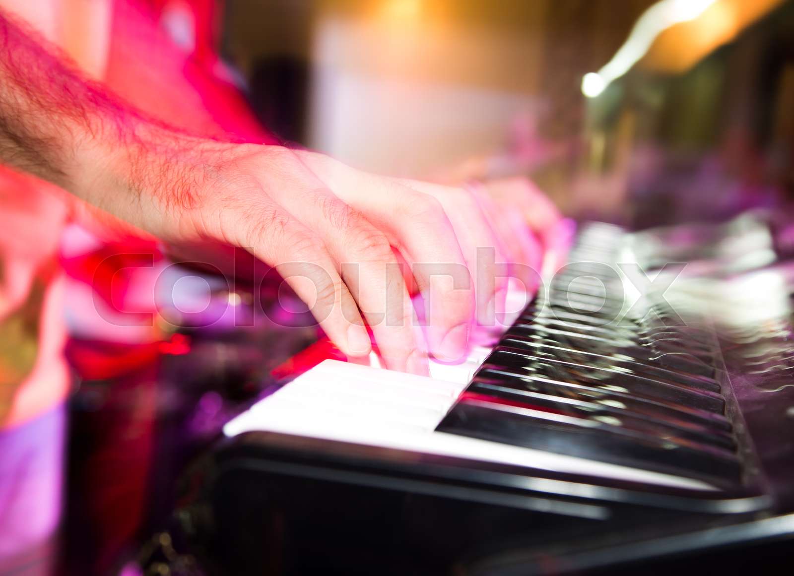 Musician plays keyboards in a rock band | Stock image | Colourbox
