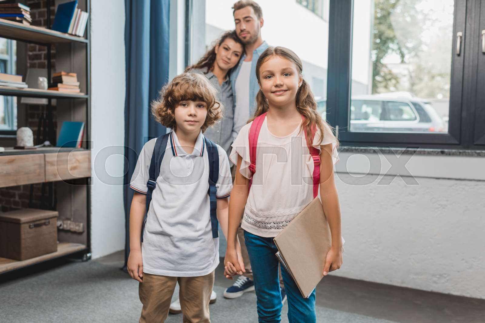 kids ready for school with parents on background | Stock image | Colourbox