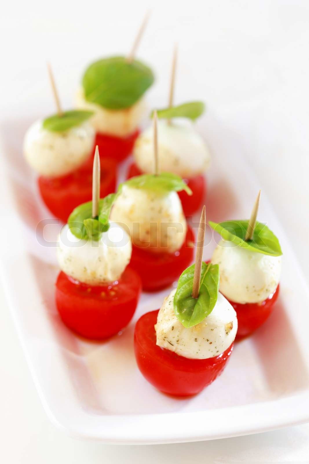 Appetizer with marinated mozzarella and snack tomatoes | Stock image ...