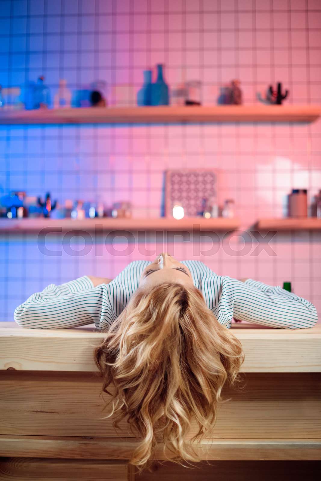 woman lying on bar counter | Stock image | Colourbox