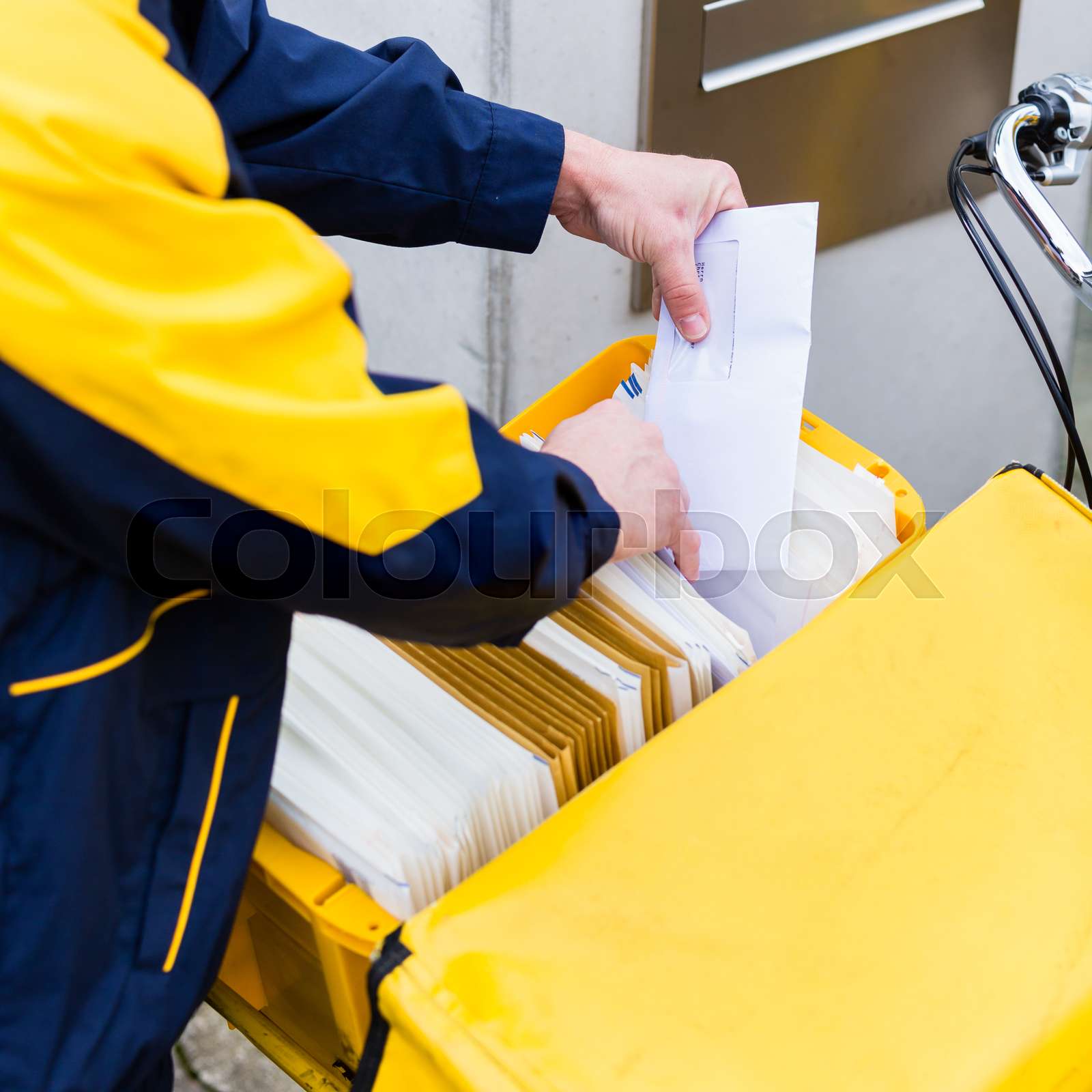 Postman delivering letters to mailbox of recipient | Stock image ...