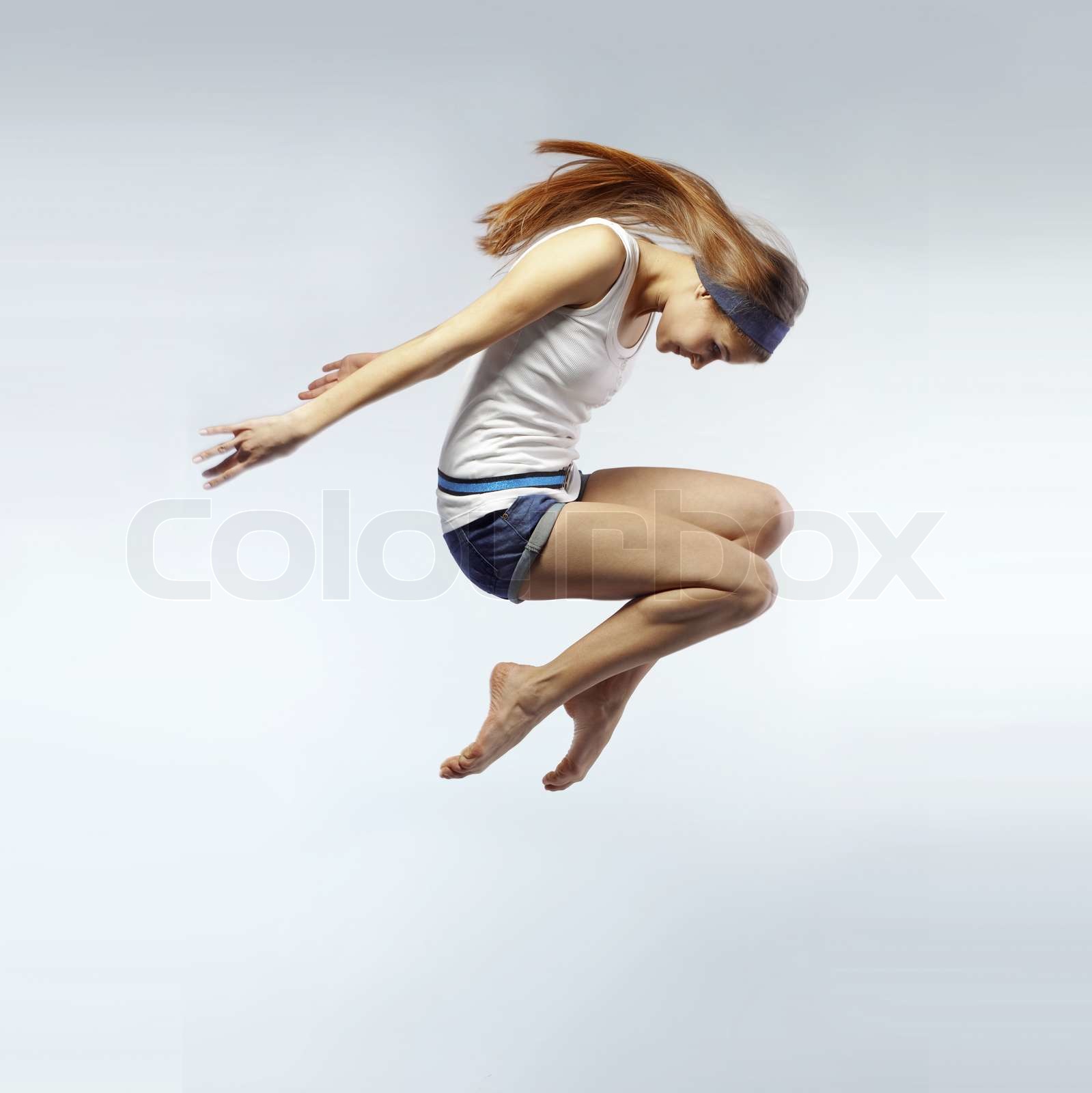 Young beautiful girl doing gymnastick jump studio series | Stock image ...