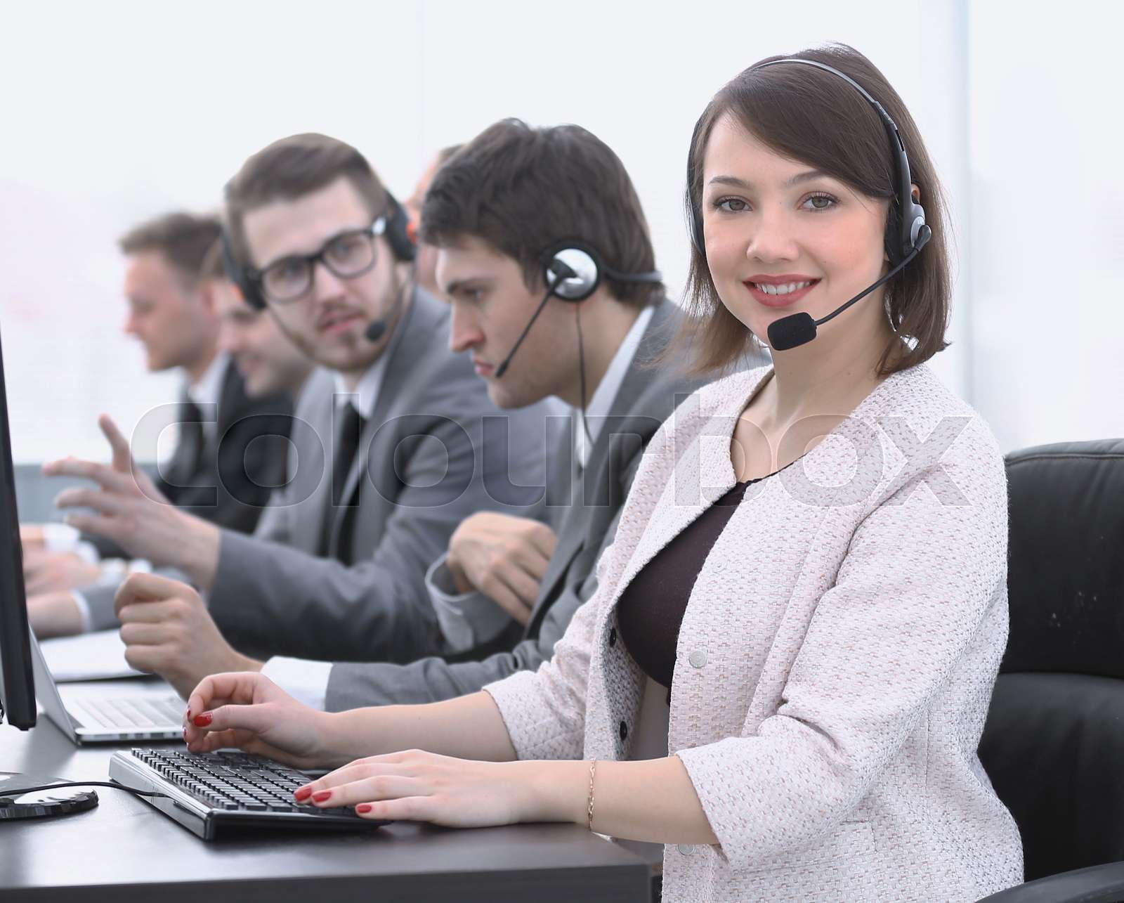 female customer service representative and colleagues in the call ...