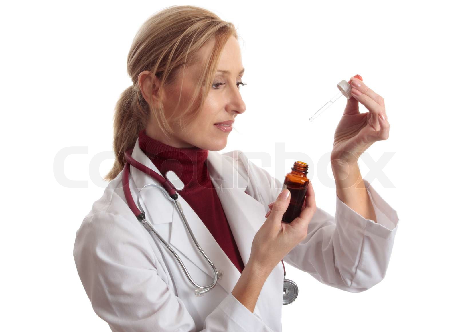 holding an ointment, homeopathic solution or other substance in her hand | Stock image | Colourbox