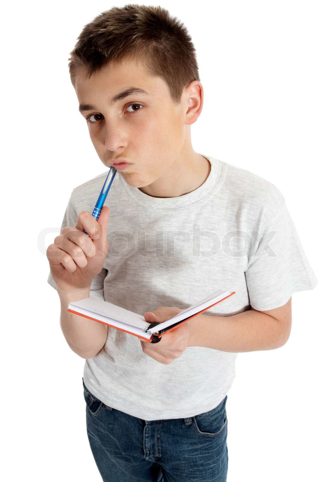 Student holding a book, pen and thinking intently | Stock image | Colourbox Student holding a book, pen and thinking intently | Stock image | Colourbox