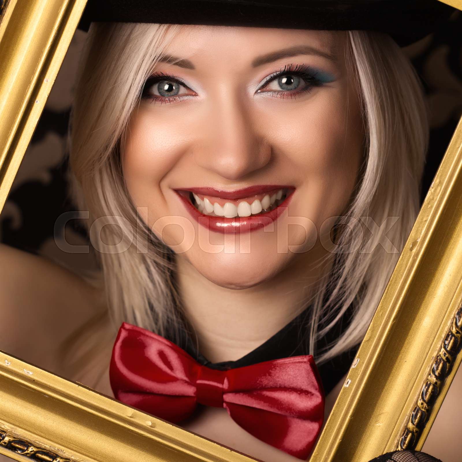 beautiful cabaret woman posing with golden frame against retro ...