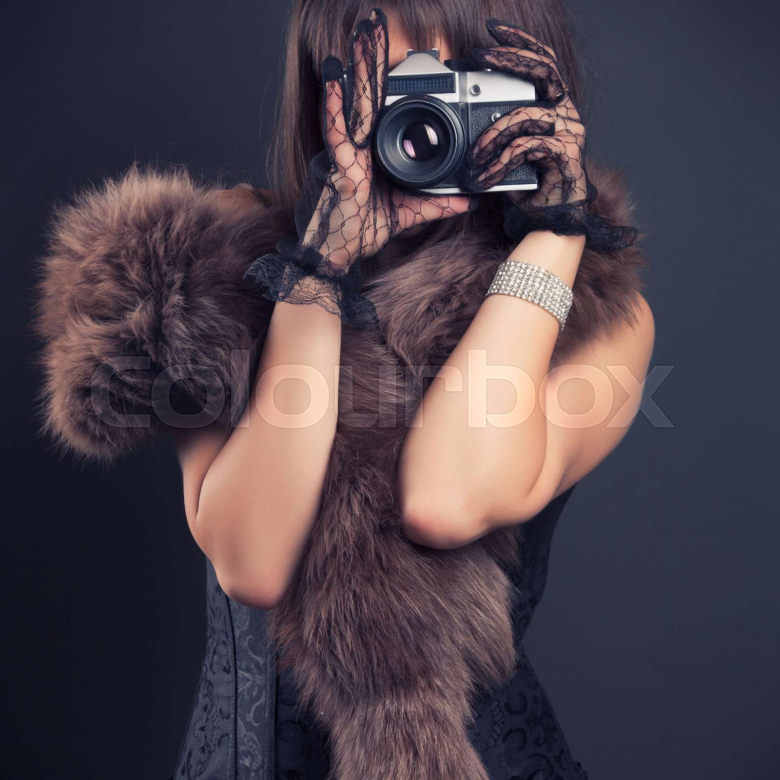 portrait of beautiful young retro woman holding vintage camera | Stock ...