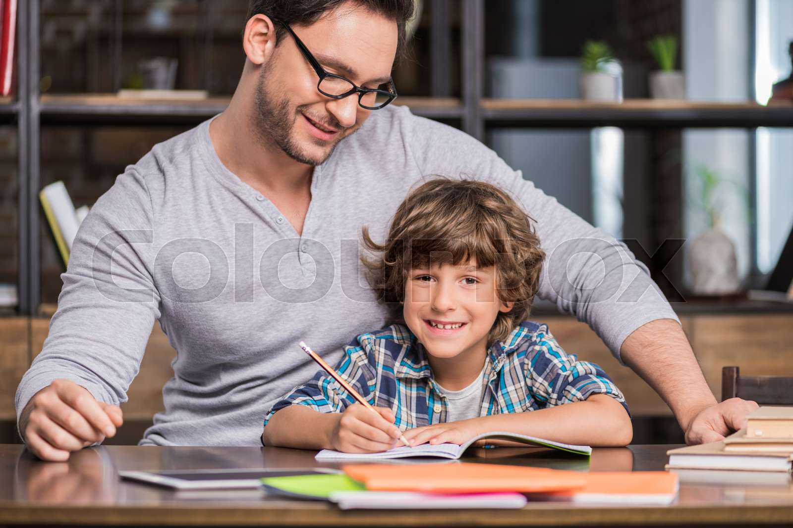 son doing homework with father | Stock image | Colourbox
