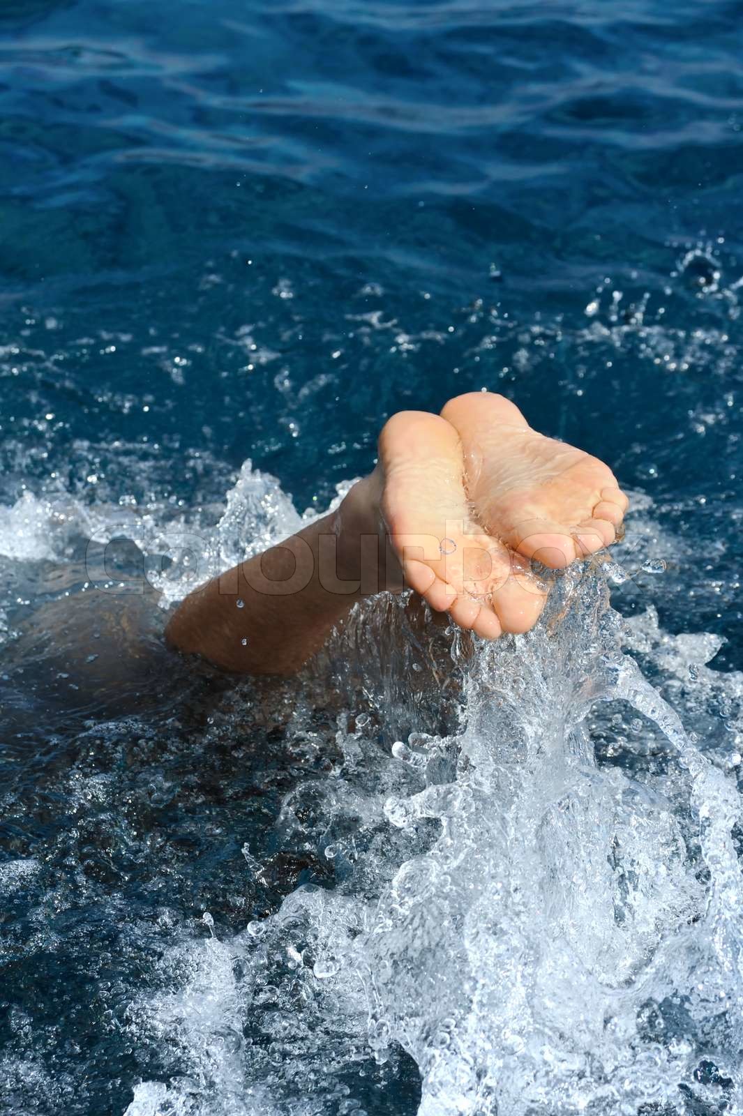Young man jumping into water | Stock image | Colourbox