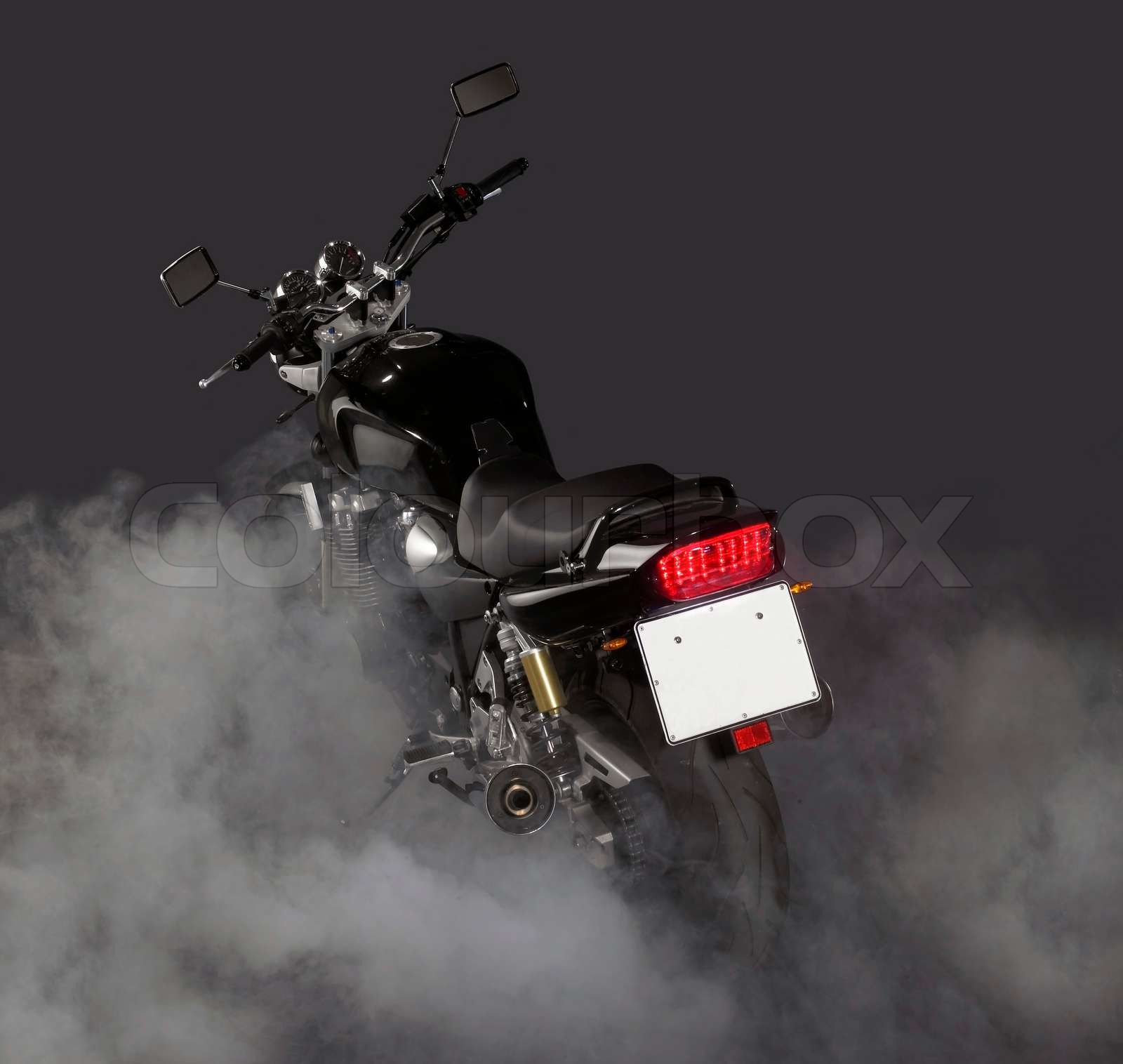detail of a motorbike and lots of smoke in dark back | Stock image ...