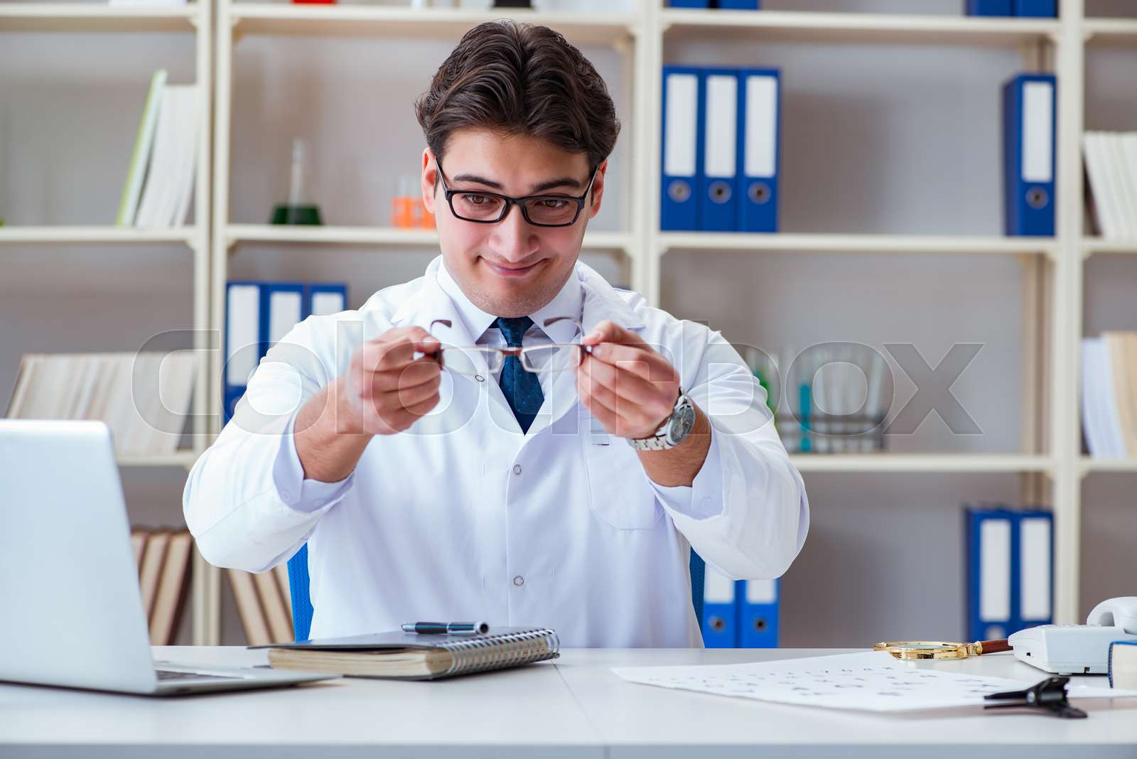 Doctor optician prescribing holding optical glasses | Stock image ...