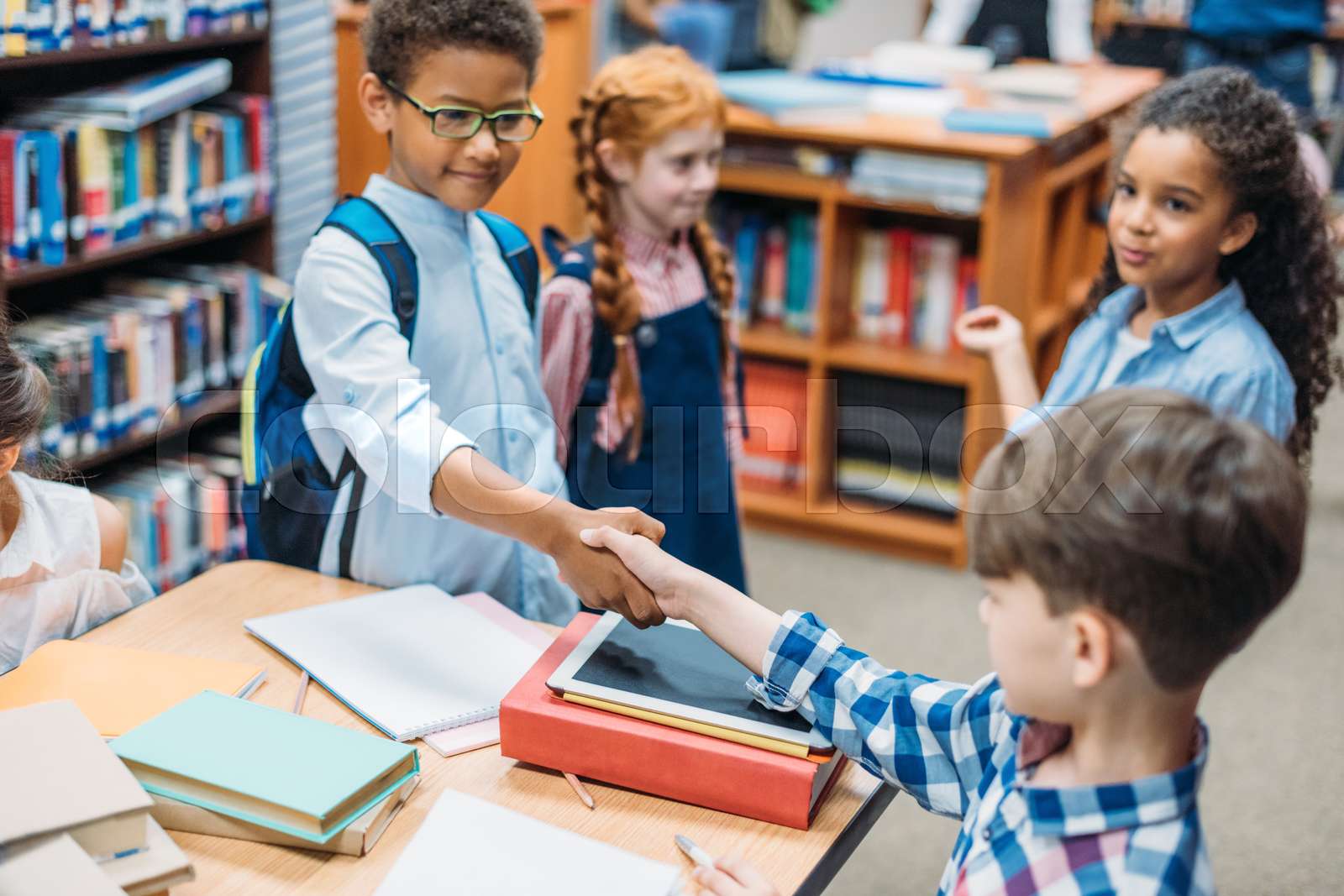 pupils shaking hands | Stock image | Colourbox