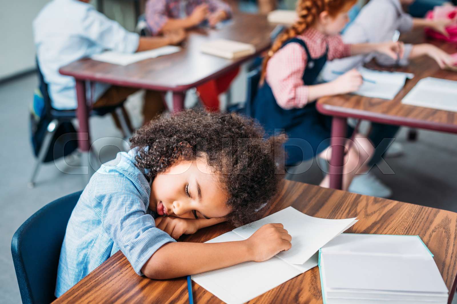 schoolgirl sleeping in class | Stock image | Colourbox