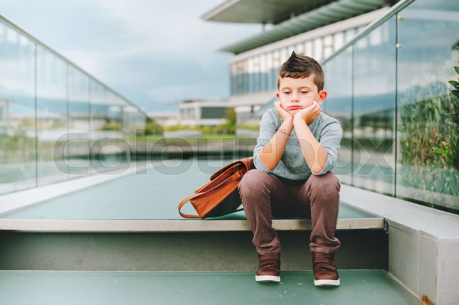 Sad kid boy resting outdoors. Bored little student | Stock image ...