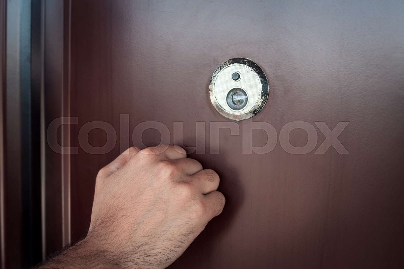Hand knocking on door. | Stock image | Colourbox