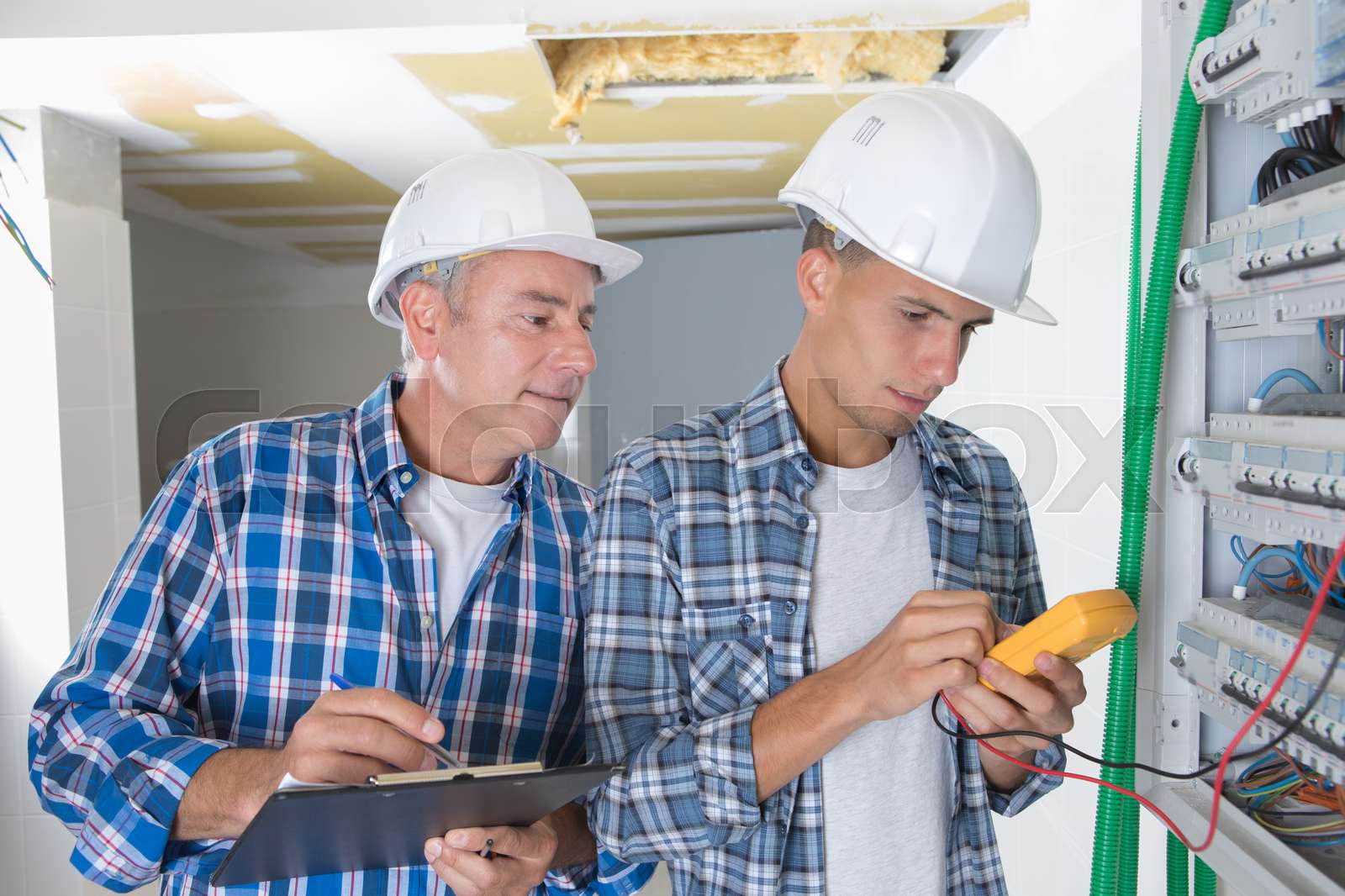 two electricians working as team | Stock image | Colourbox