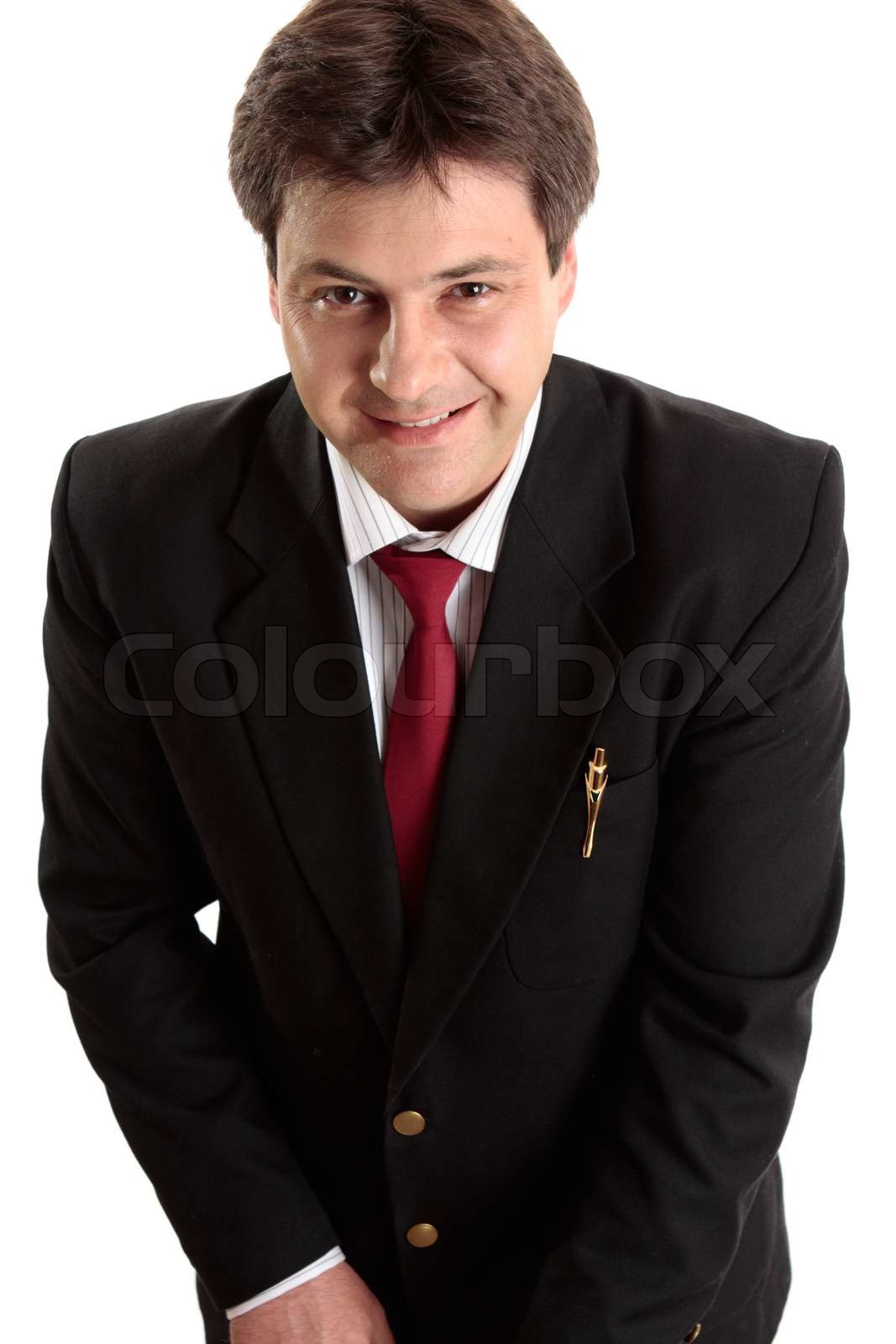 Businessman or salesman in a black suit looks up and smiles cheerfully ...