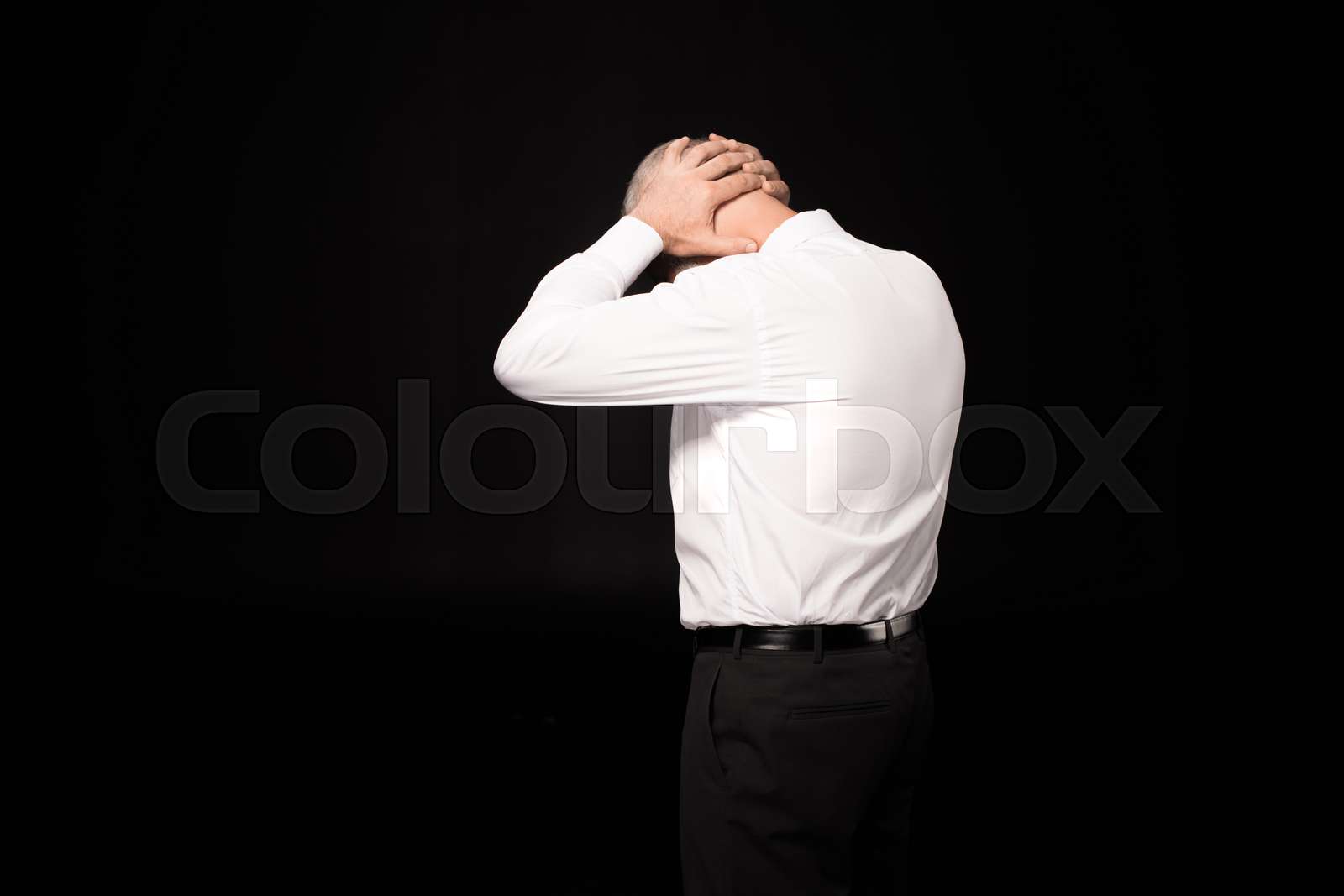 Man clasping hands on nape of neck | Stock image | Colourbox