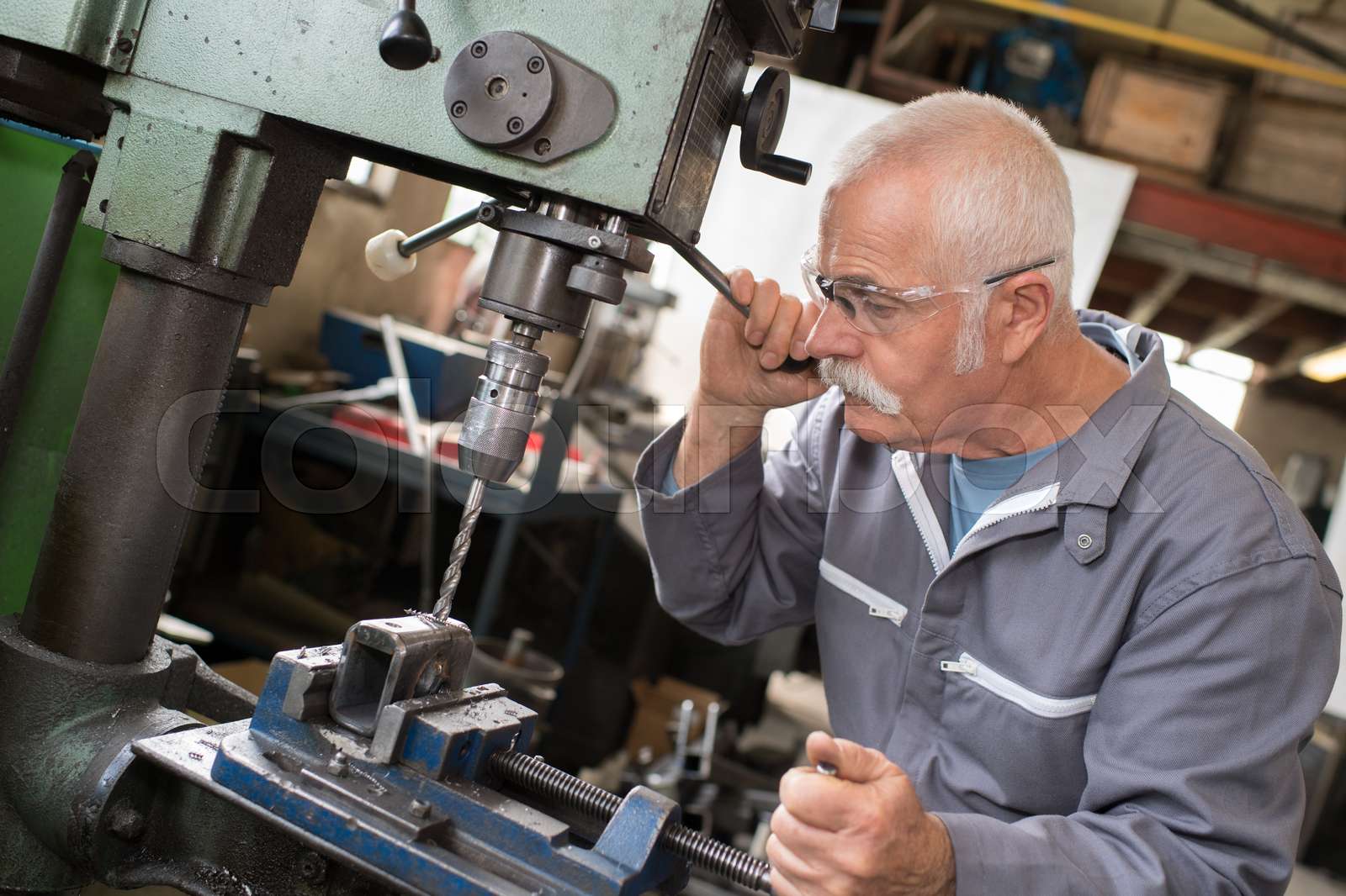 mechanic using industrial lathe machine | Stock image | Colourbox