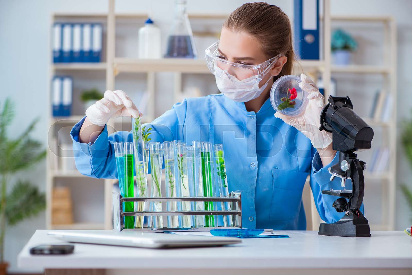 Female scientist researcher conducting an experiment in a labora ...