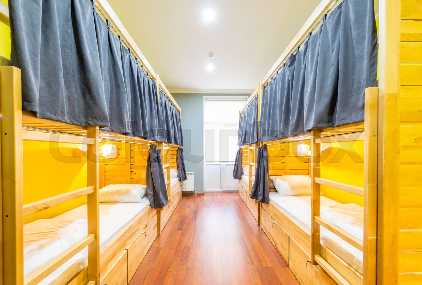 Hostel dormitory beds arranged in room | Stock image | Colourbox