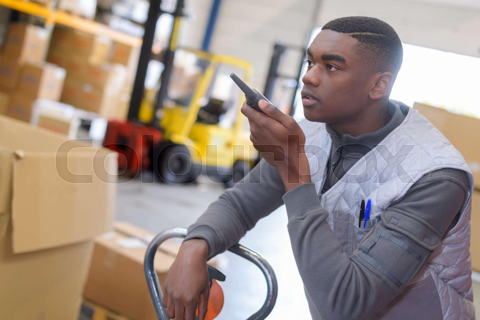 worker using phone in warehouse | Stock image | Colourbox