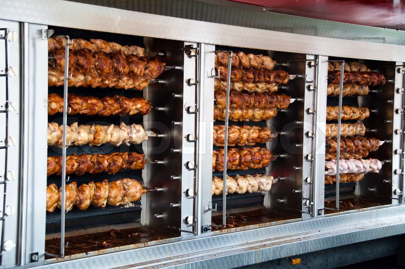 some roasting chicken on large grills barbecue in a van | Stock image ...