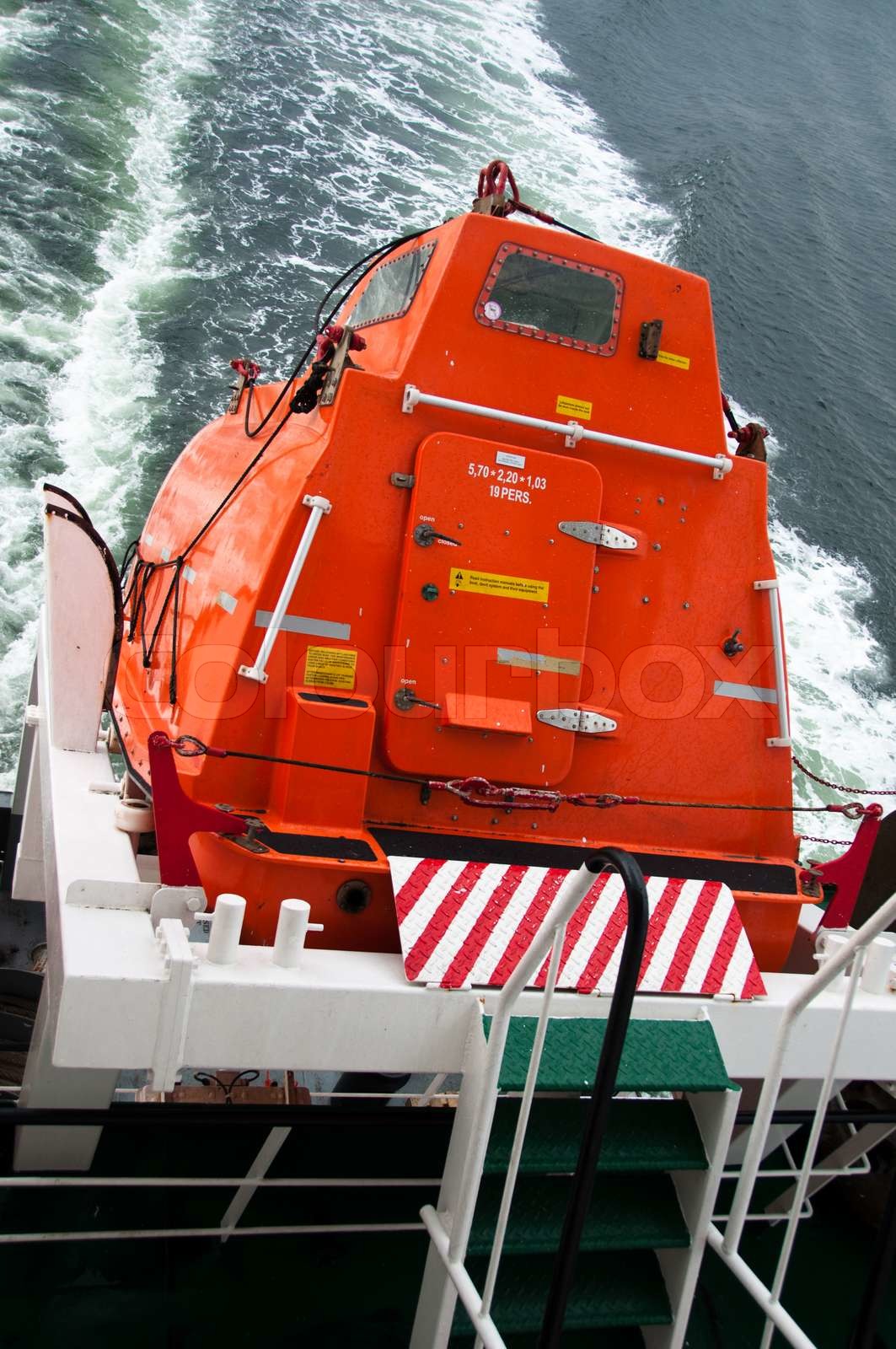 A freefall lifeboat on a cargo ship ready for rescue | Stock image ...