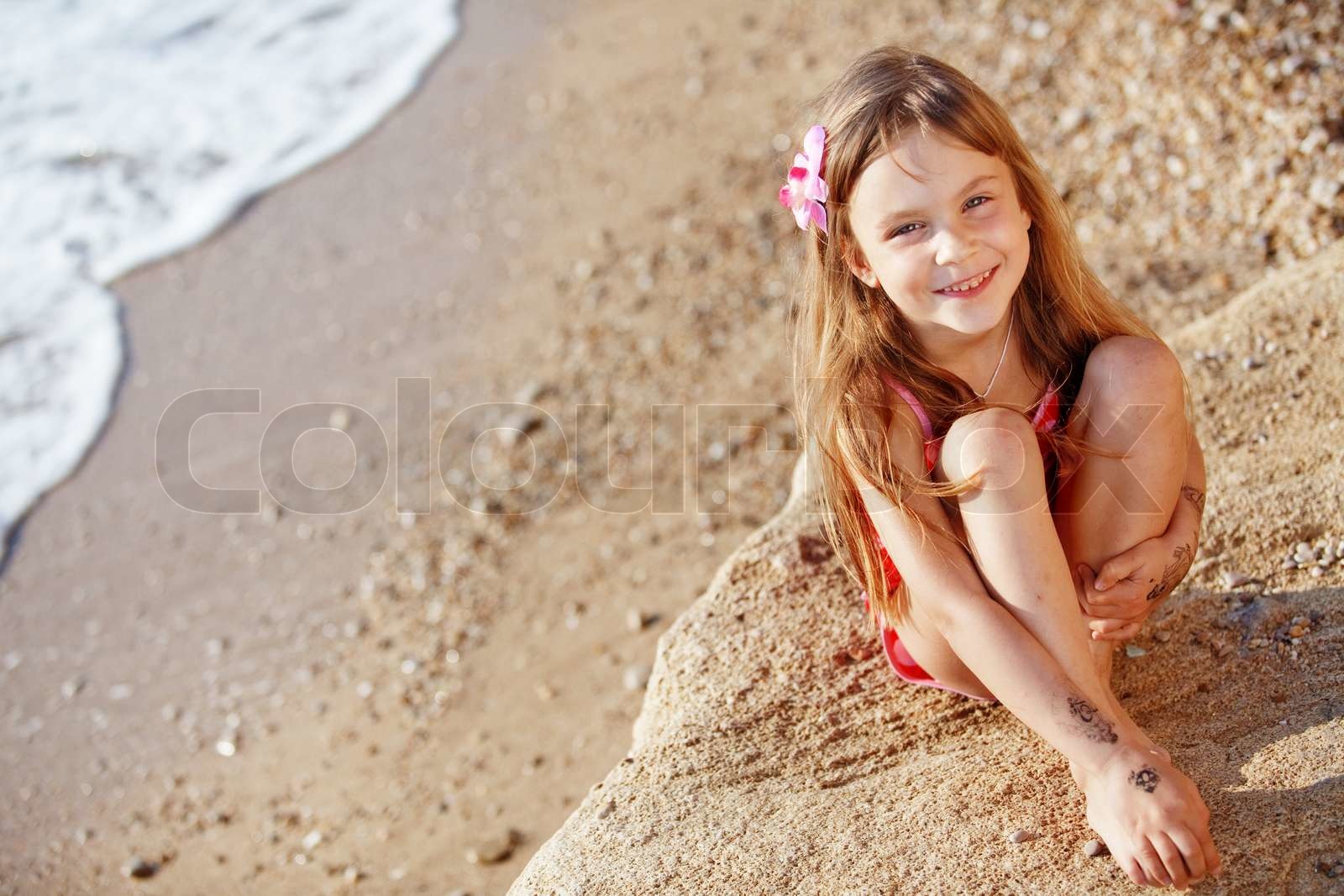 Cute child wearing swimsuit resting at beach in summer | Stock image ...