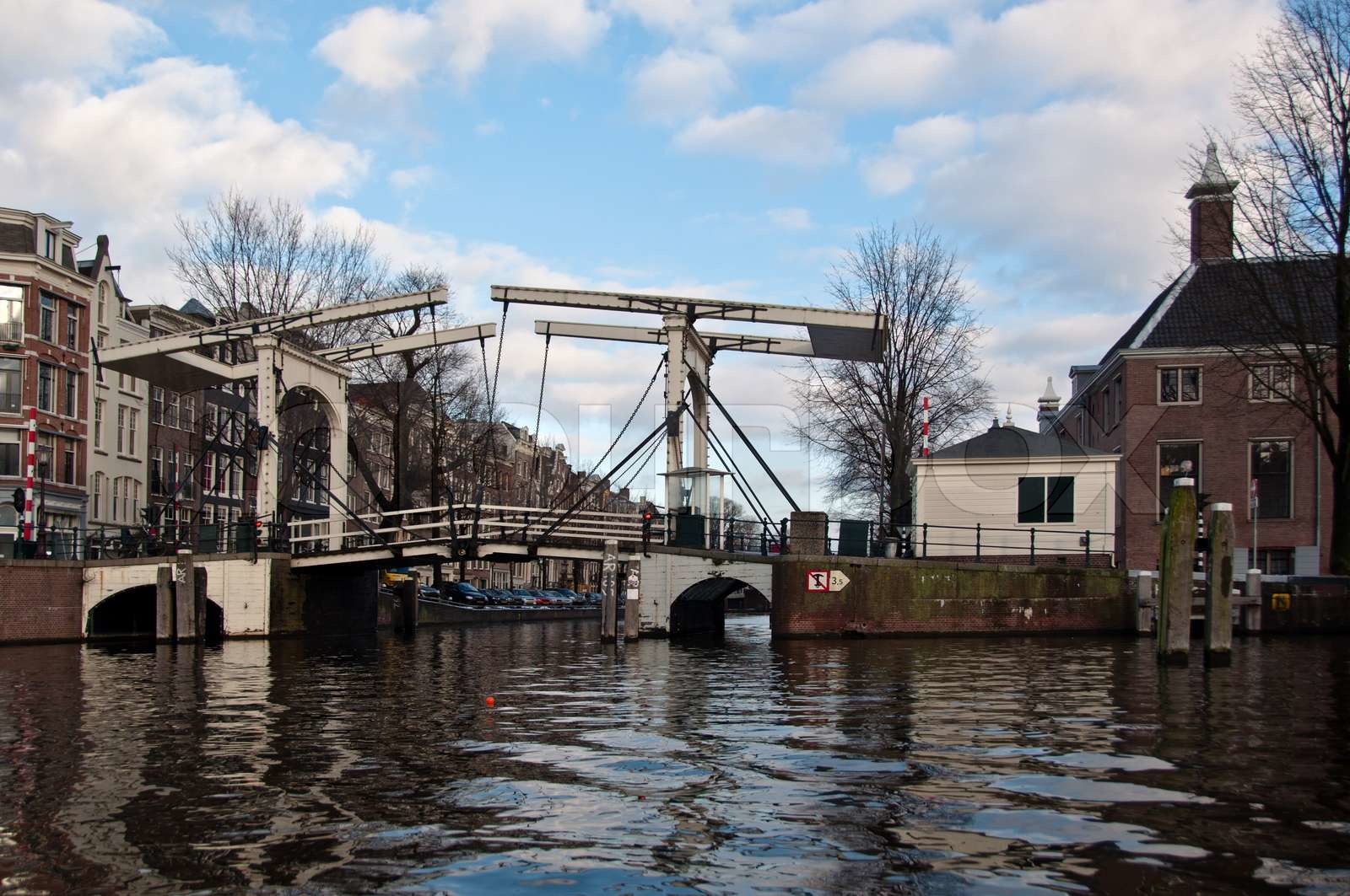 Typical wooden drawbridge over a canal in Amsterdam, Netherlands ...