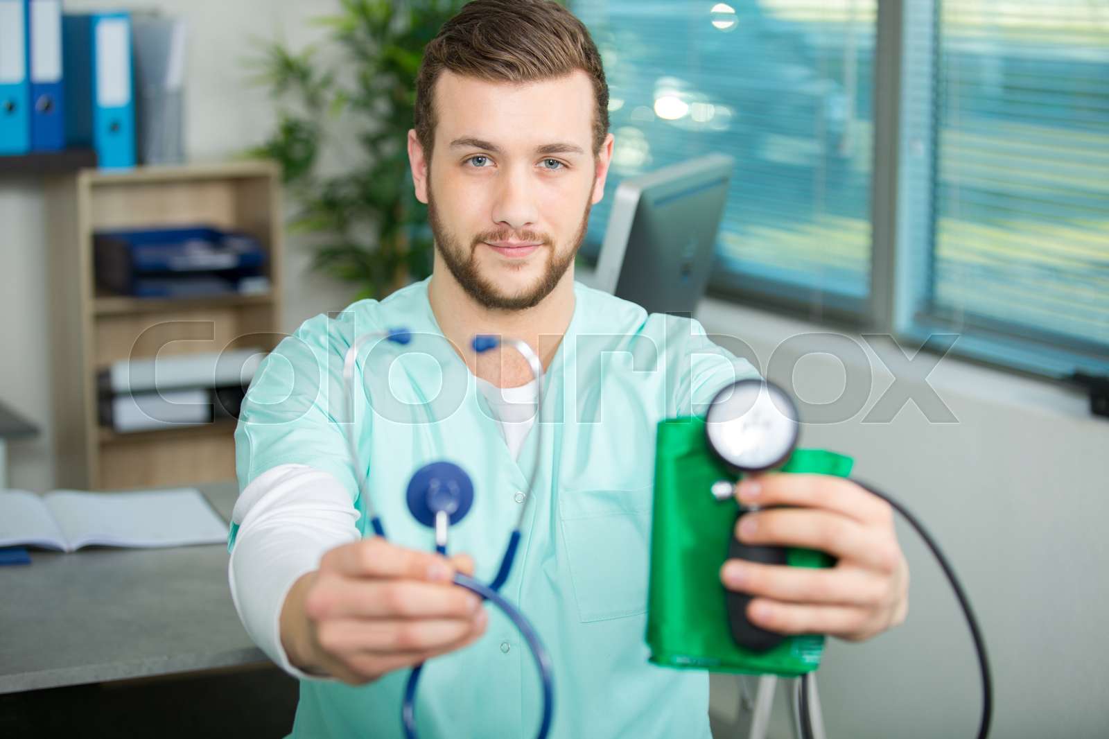 nurse holding blood pressure measuring equipment | Stock image | Colourbox