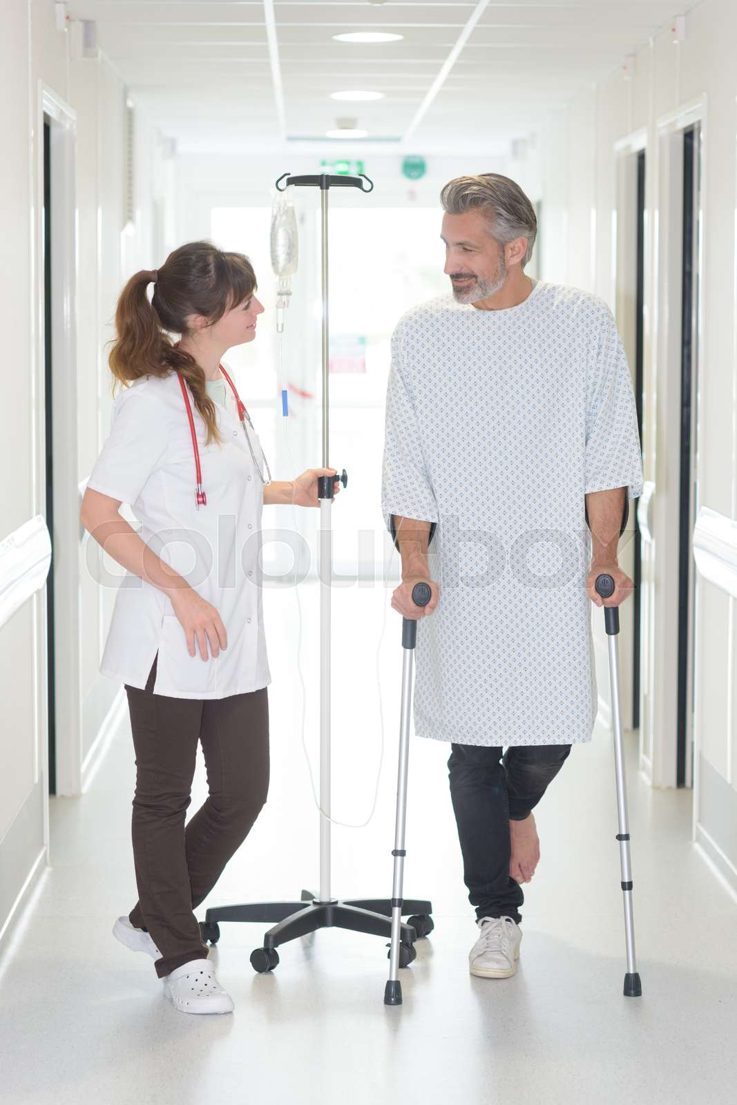 patient using cane while looking at female doctor | Stock image | Colourbox