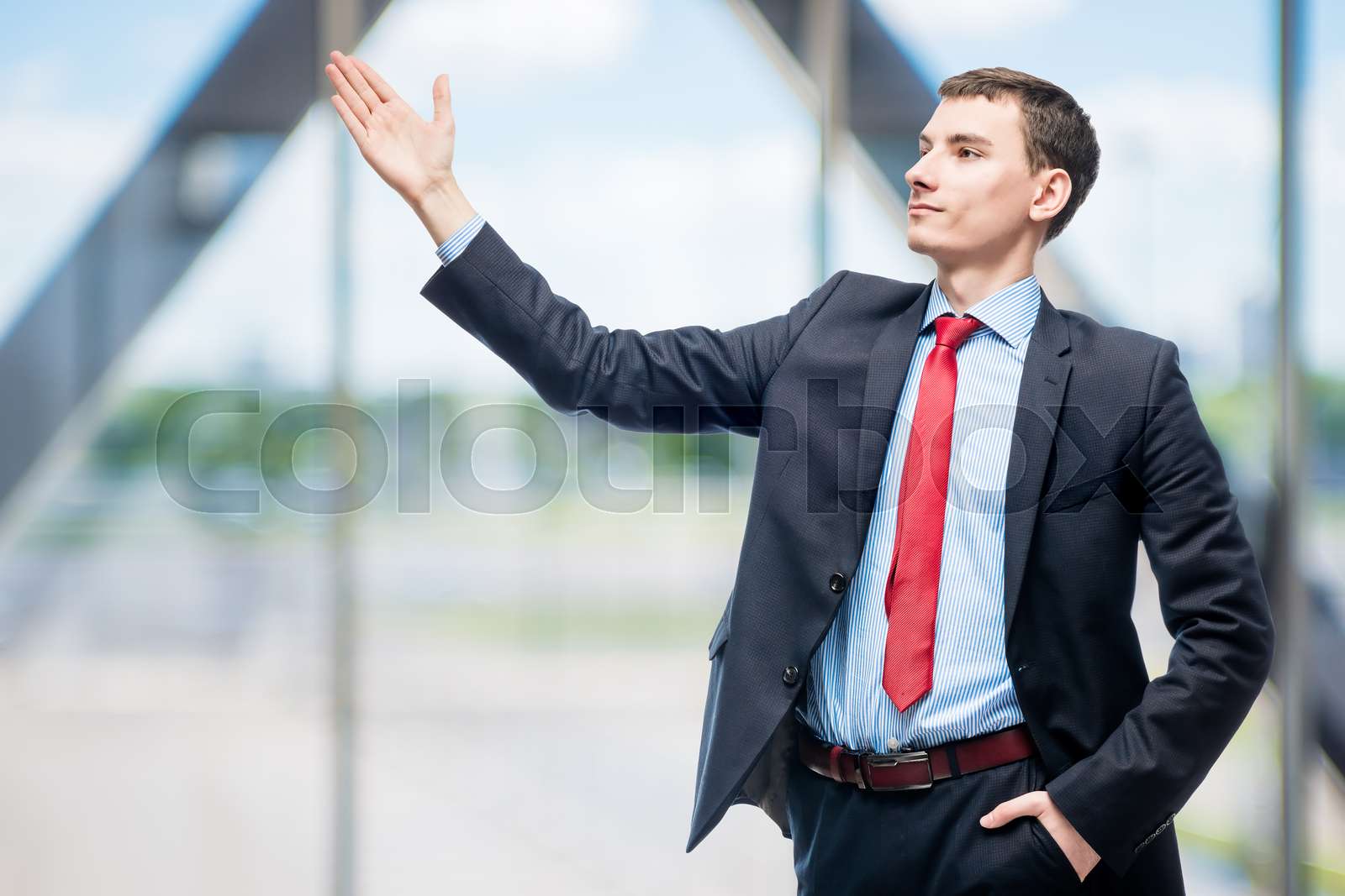 Successful young boss gestures with hands in office | Stock image ...