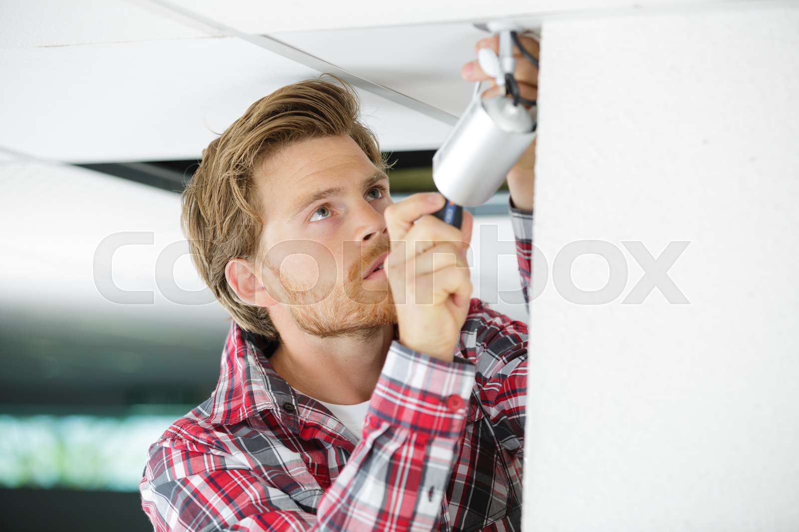 technician man setting up cctv camera on ceiling | Stock image | Colourbox