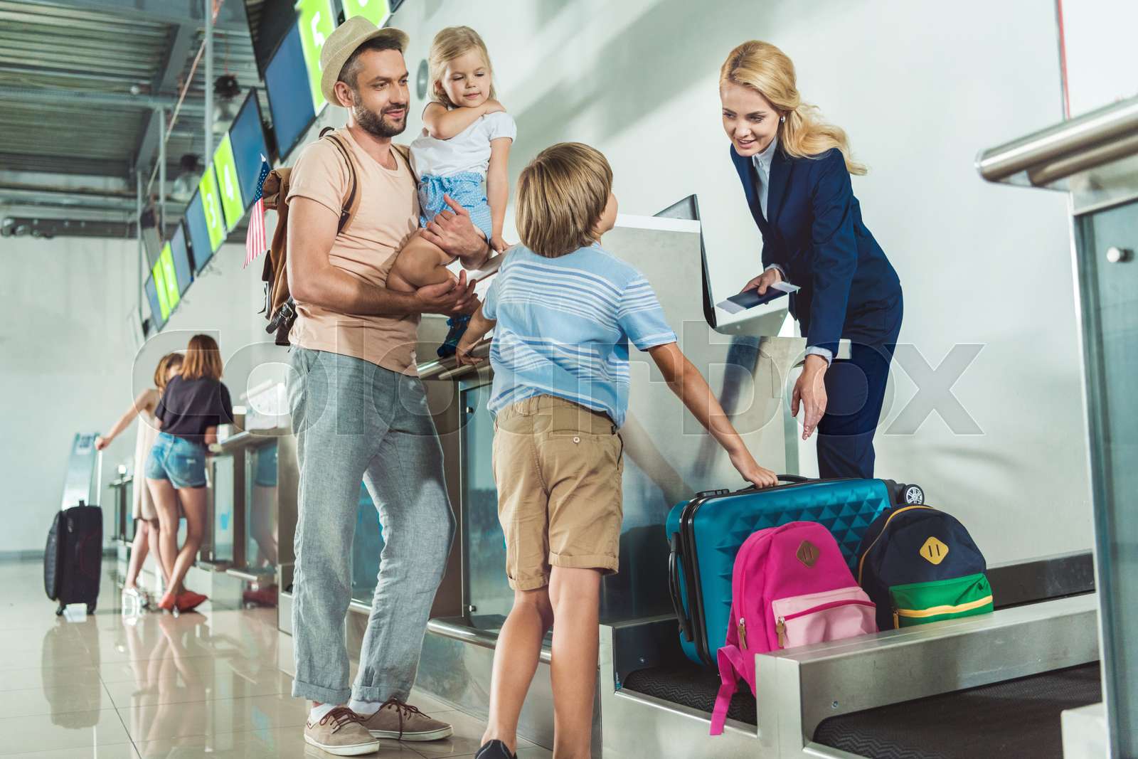 family at check in desk in airport | Stock image | Colourbox