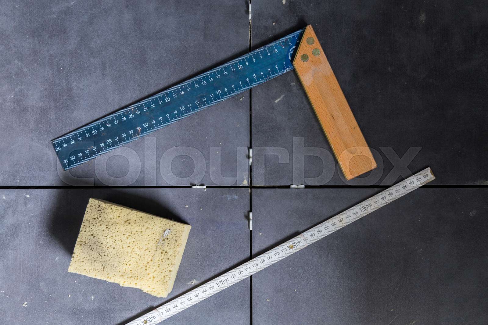 Tiles concept tool, angle, ruler, sponge on tiles top view | Stock ...