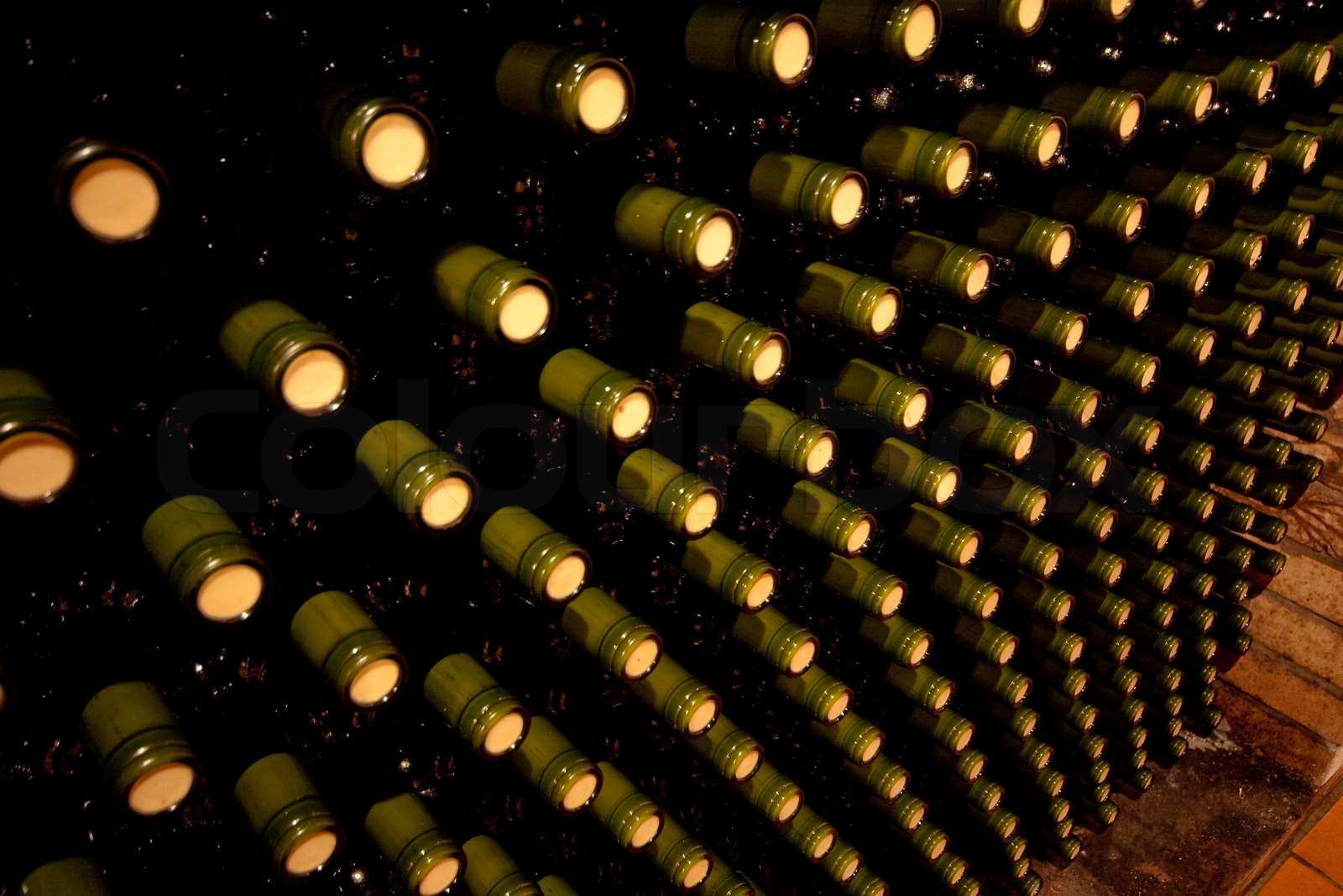 stacked up wine bottles in the cellar | Stock image | Colourbox