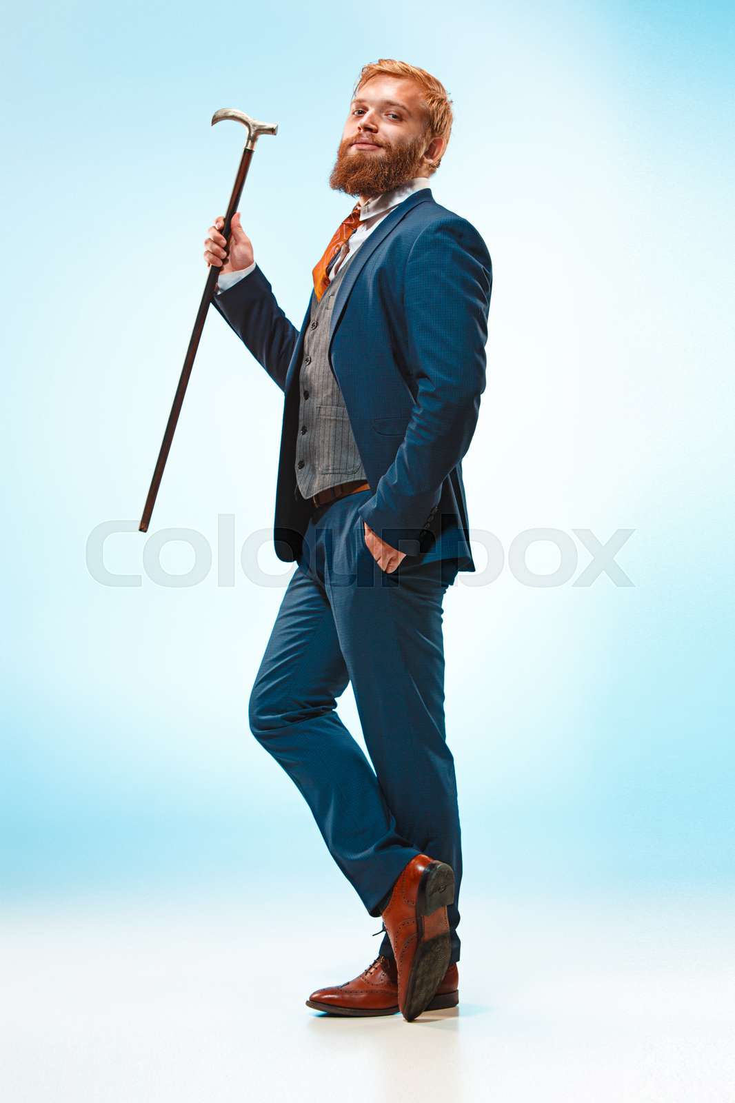 The barded man in a suit holding cane. | Stock image | Colourbox
