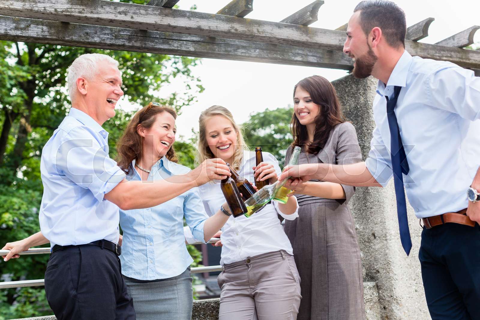 Office colleagues drinking beer after work | Stock image | Colourbox