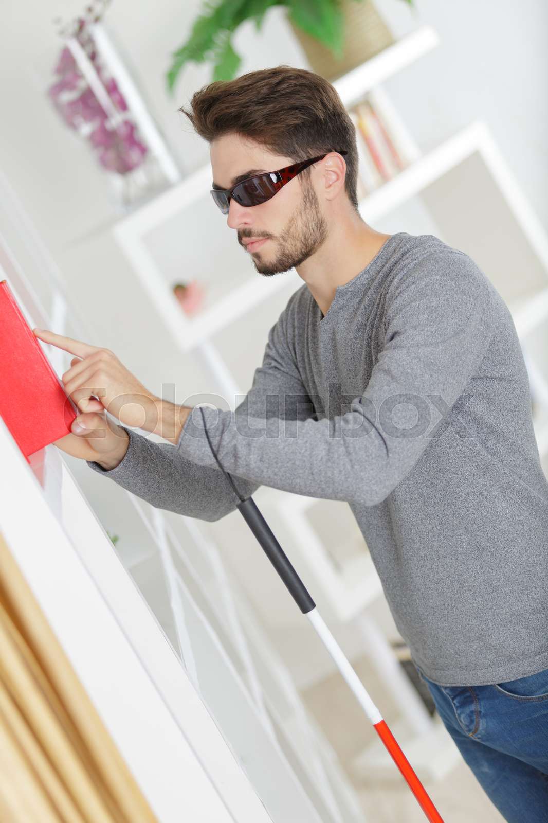 blind man with white stick and dark glasses at home | Stock image ...